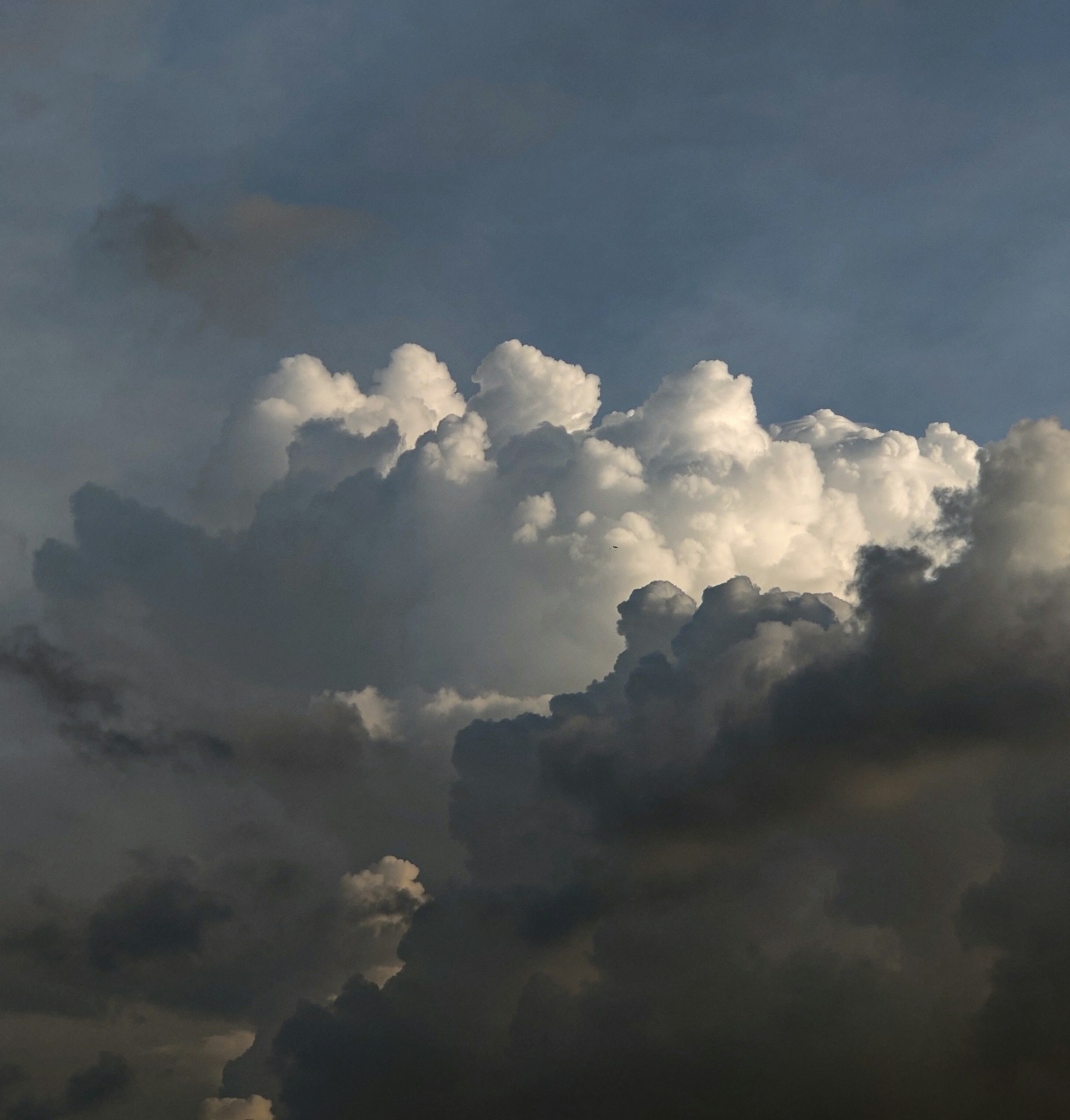 Sunlit Crest Rising Over a Dark Cloudscape