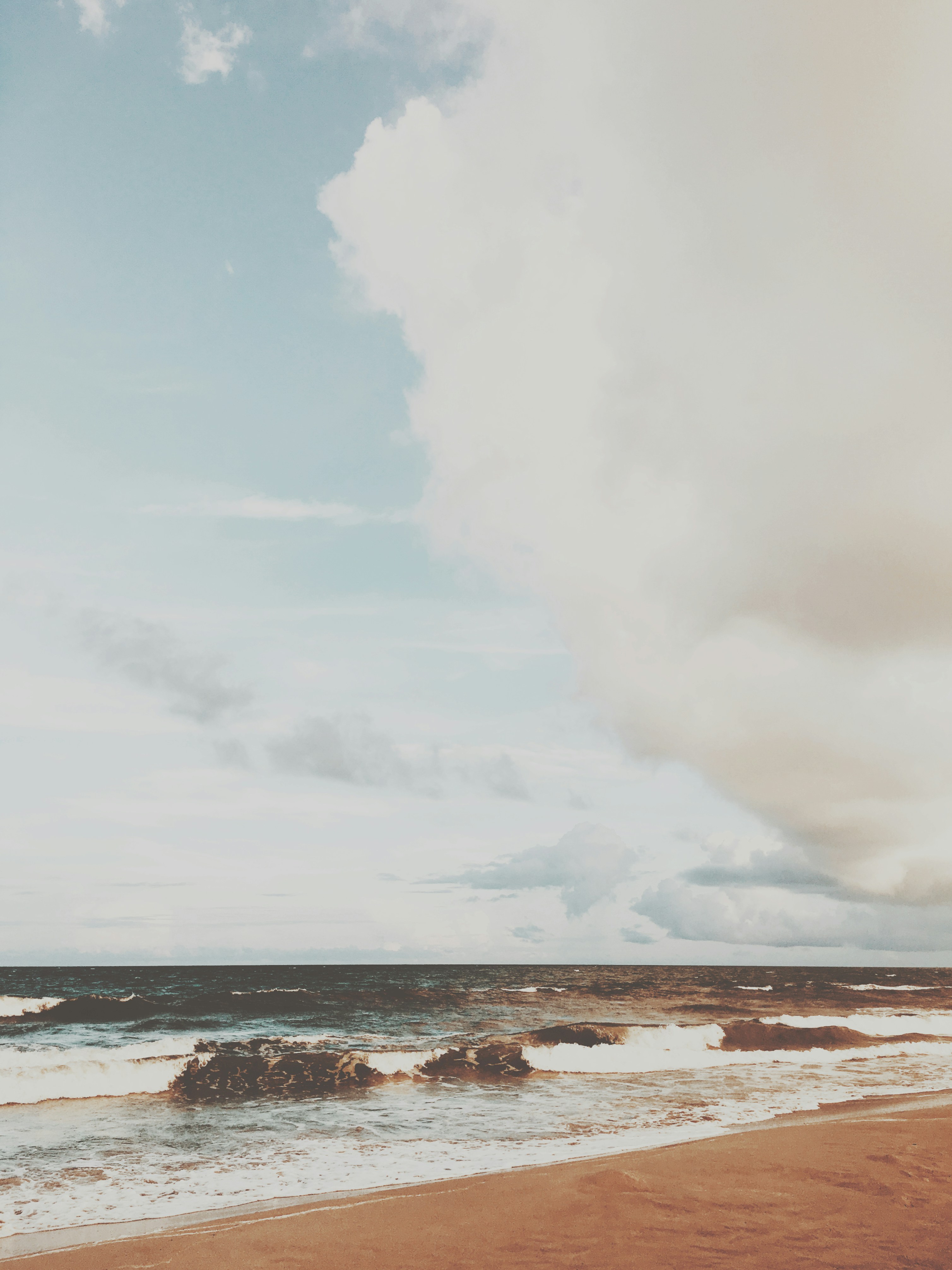 A beach with rocks and water photo – Free Cocoa beach Image on Unsplash