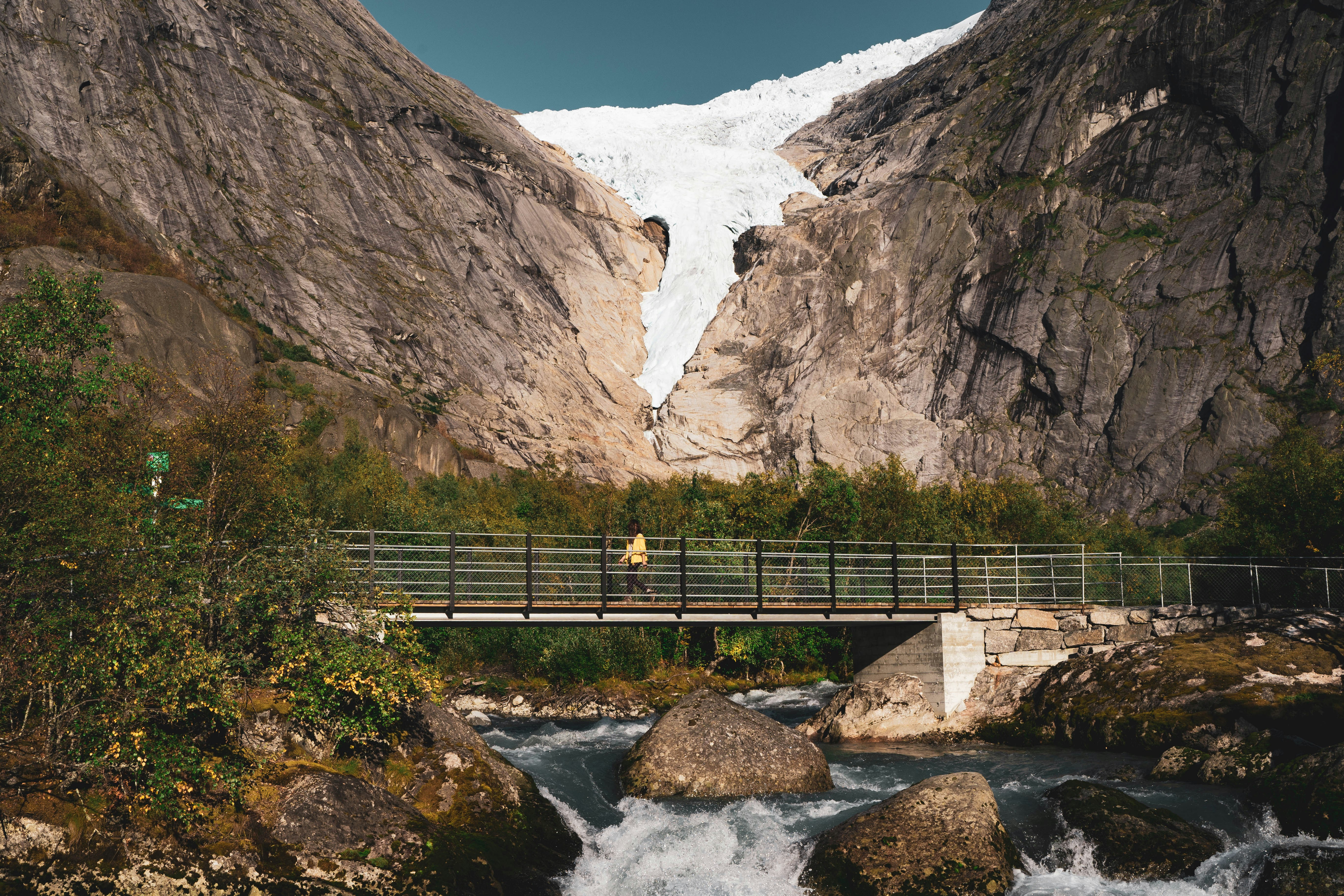 Bridge Over a Glacial Gorge Under a Snowbound Wall