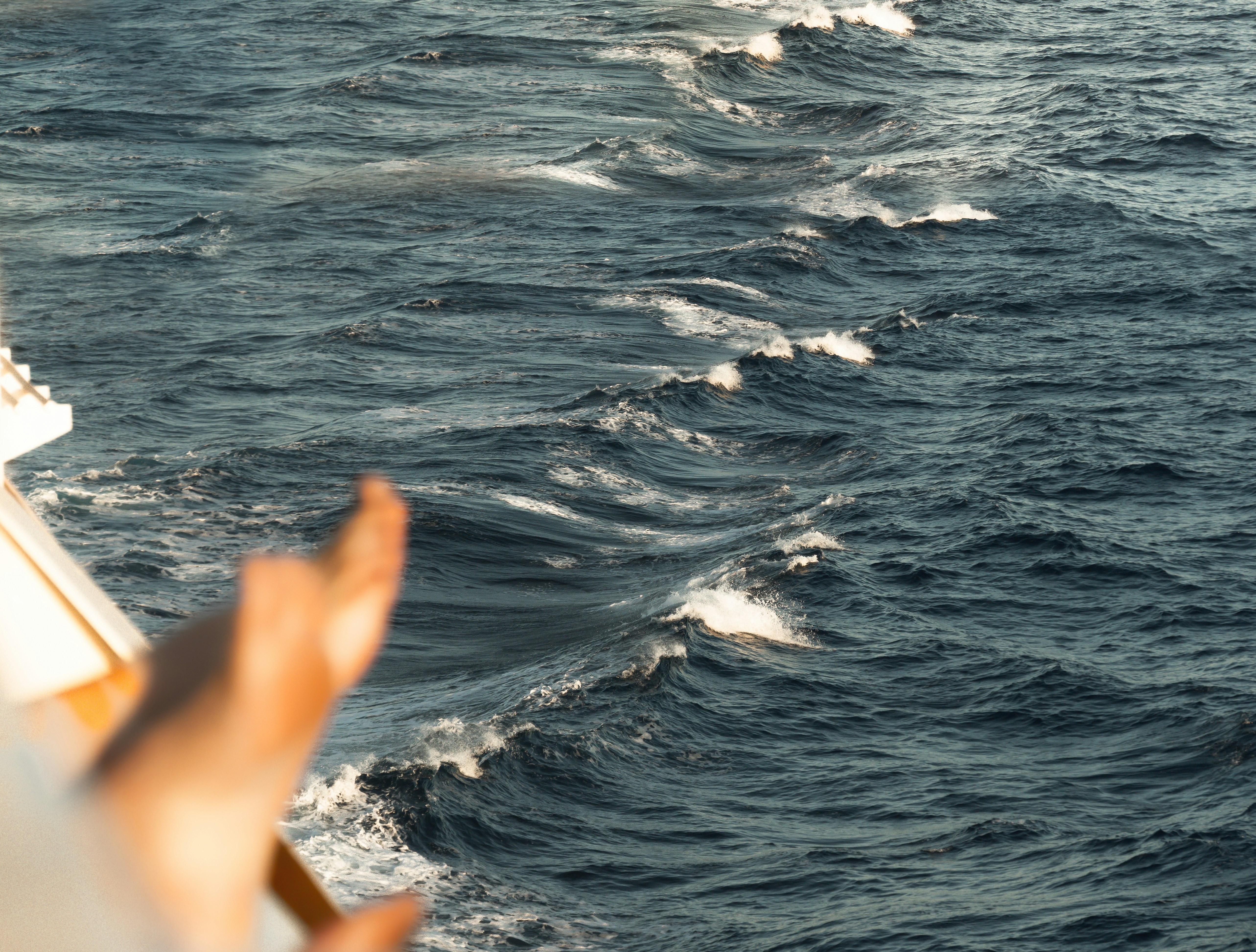 Foam-Lined Wake Across a Sea-Blue Canvas