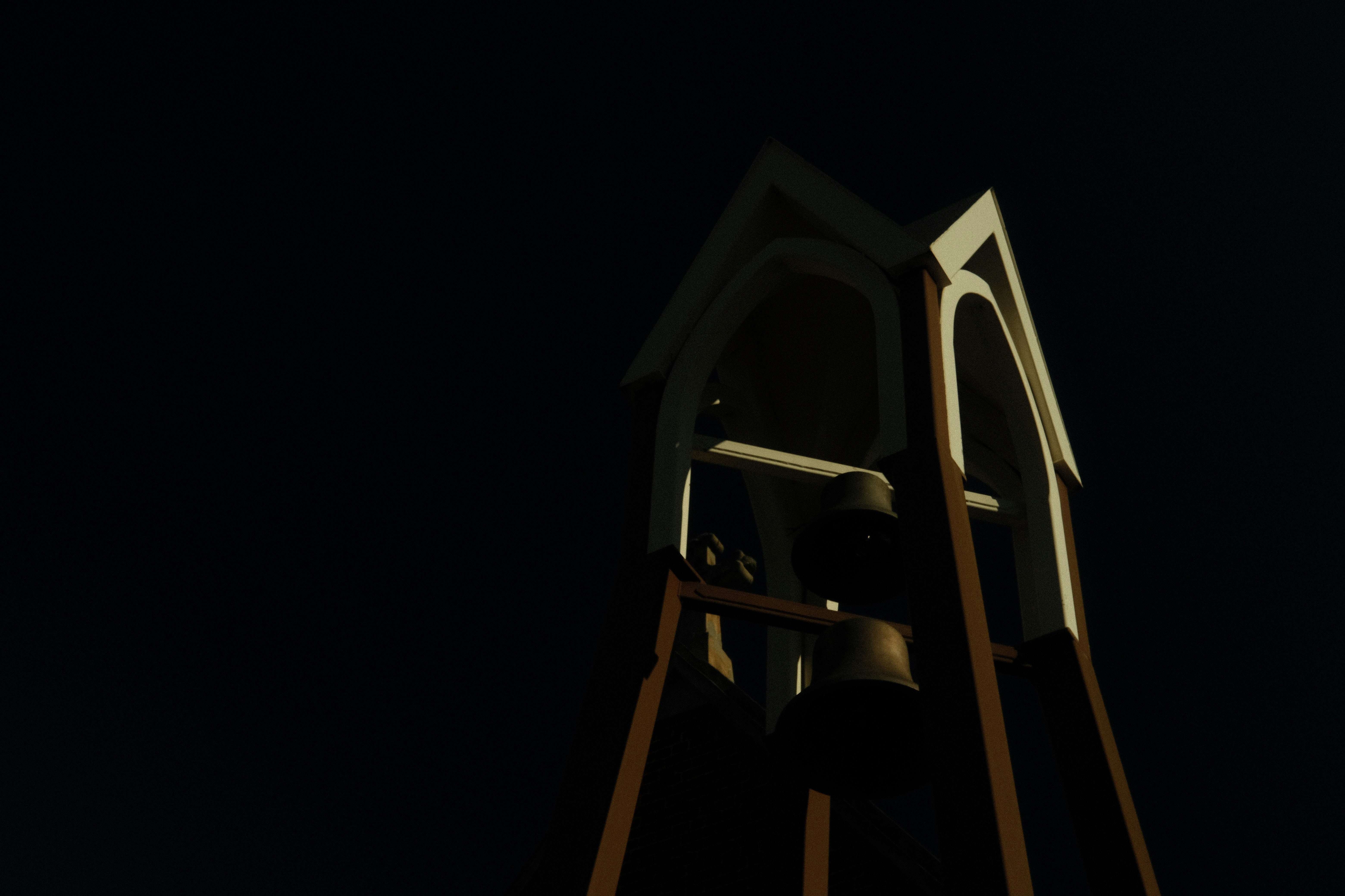 Three Bells in the Dark: A Quiet Bell Tower in Shadow