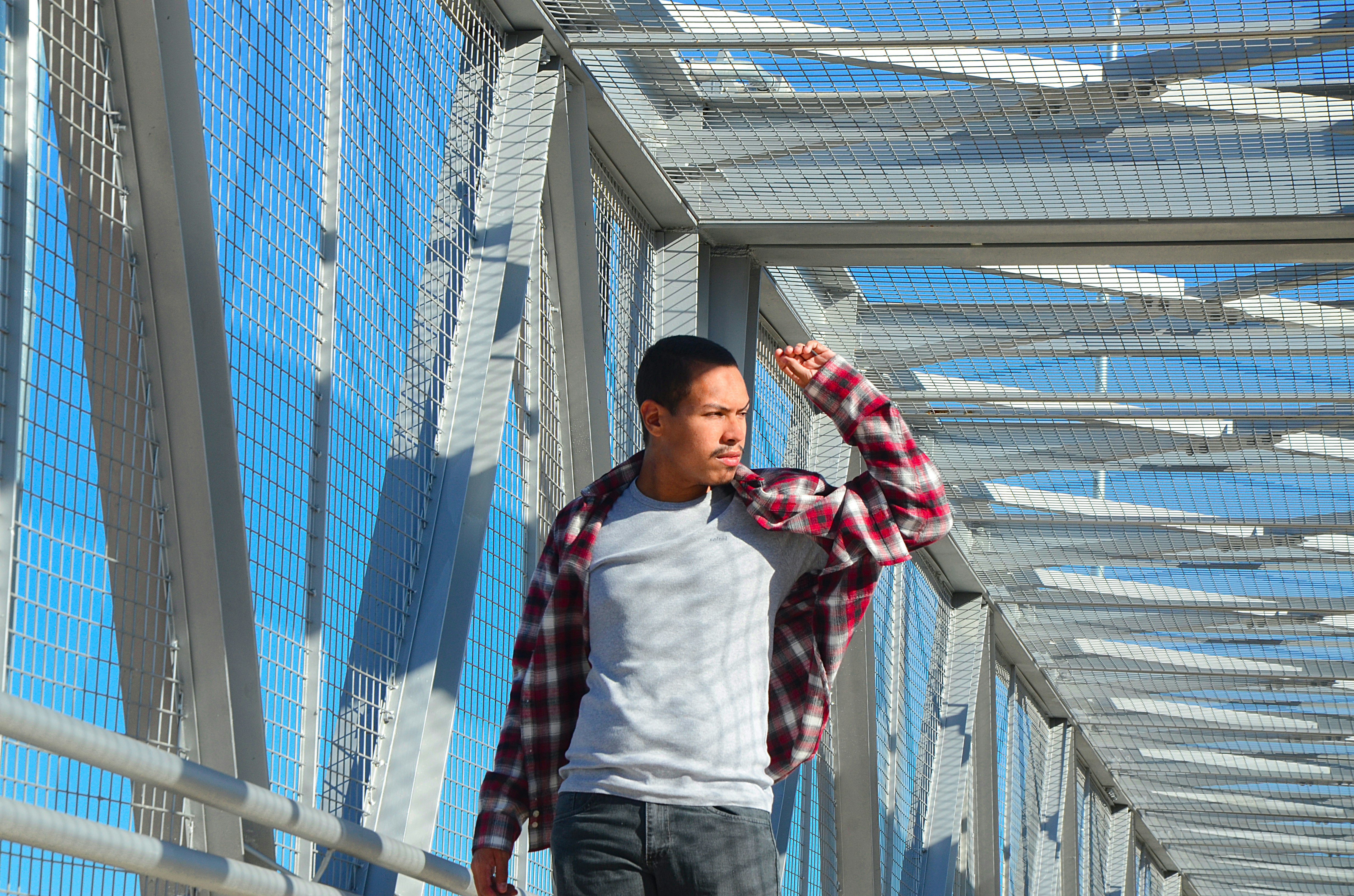 Portrait on the Skywalk: Focus Amid Steel Grids and Blue Sky