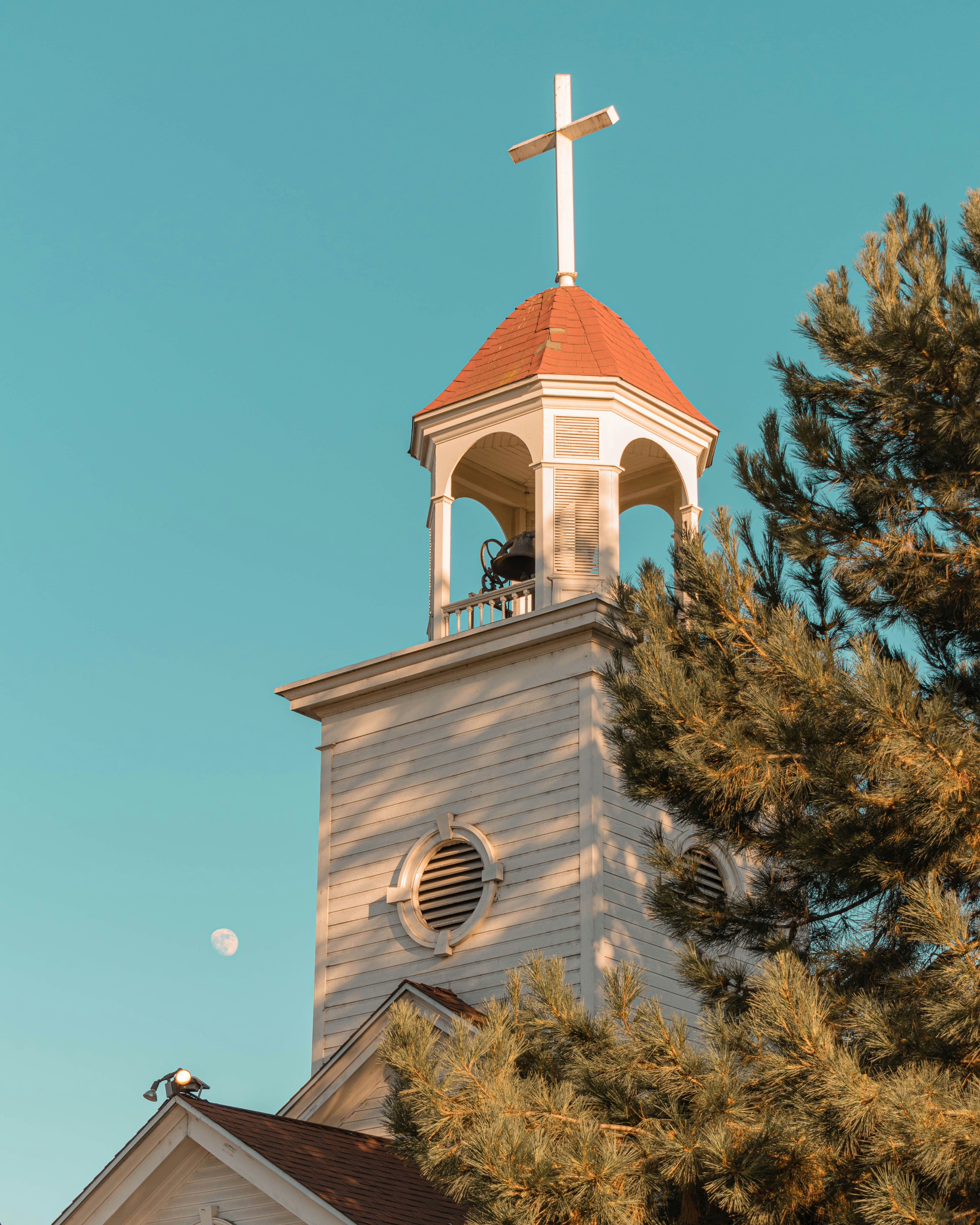 Teal Sky over a White Bell Tower with a Red Cupola and a Moon