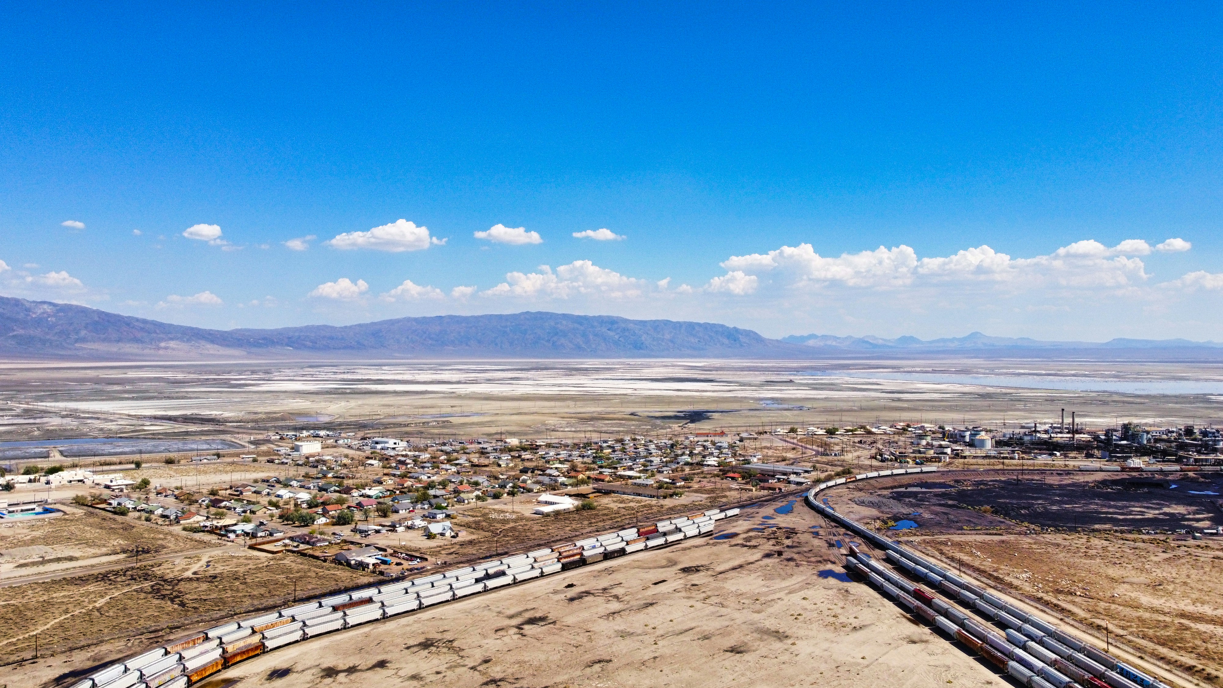 Railway Ribbon through Arid Plains under a Wide Sky