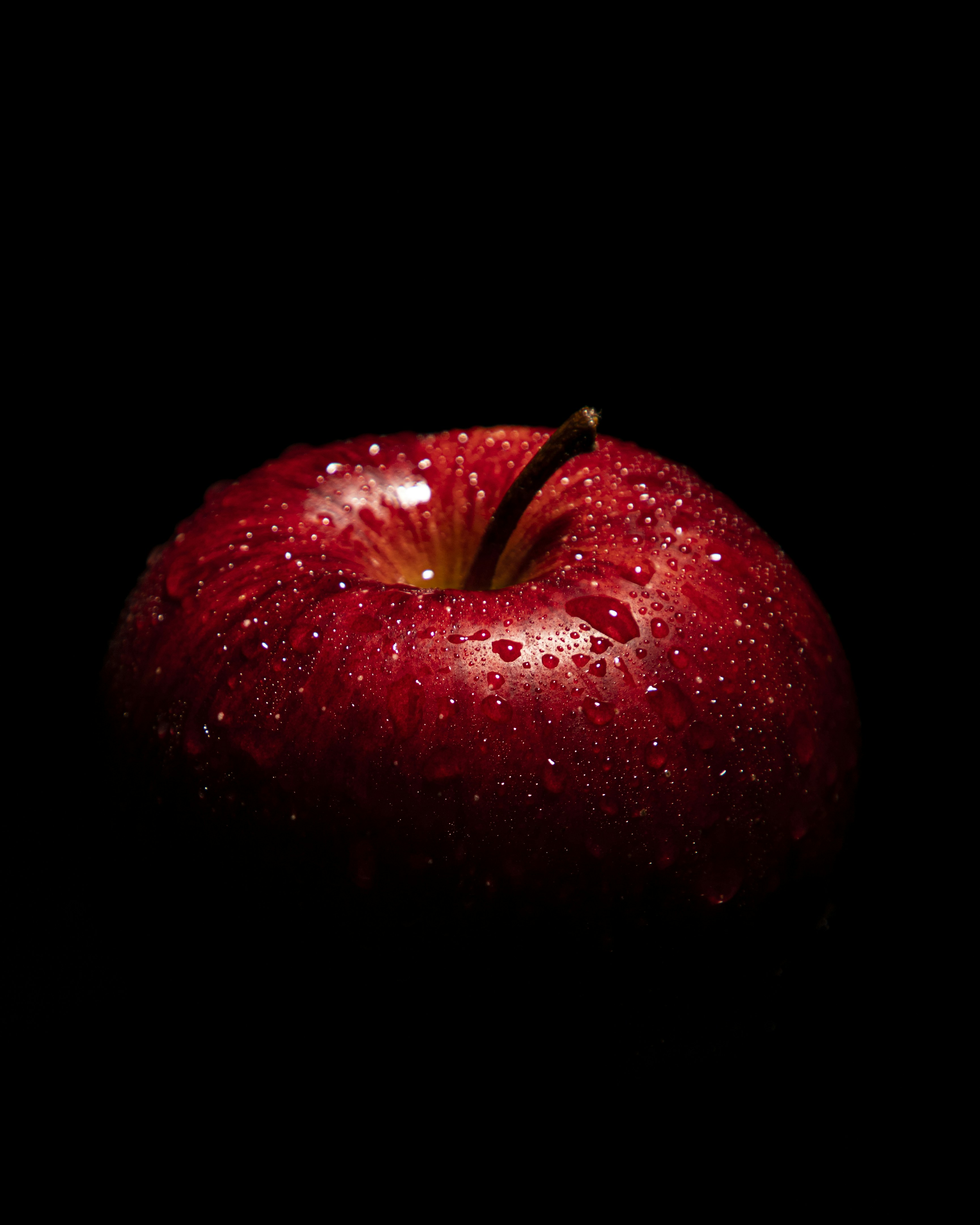 Dew-Kissed Crimson Apple Against Velvet Black Backdrop