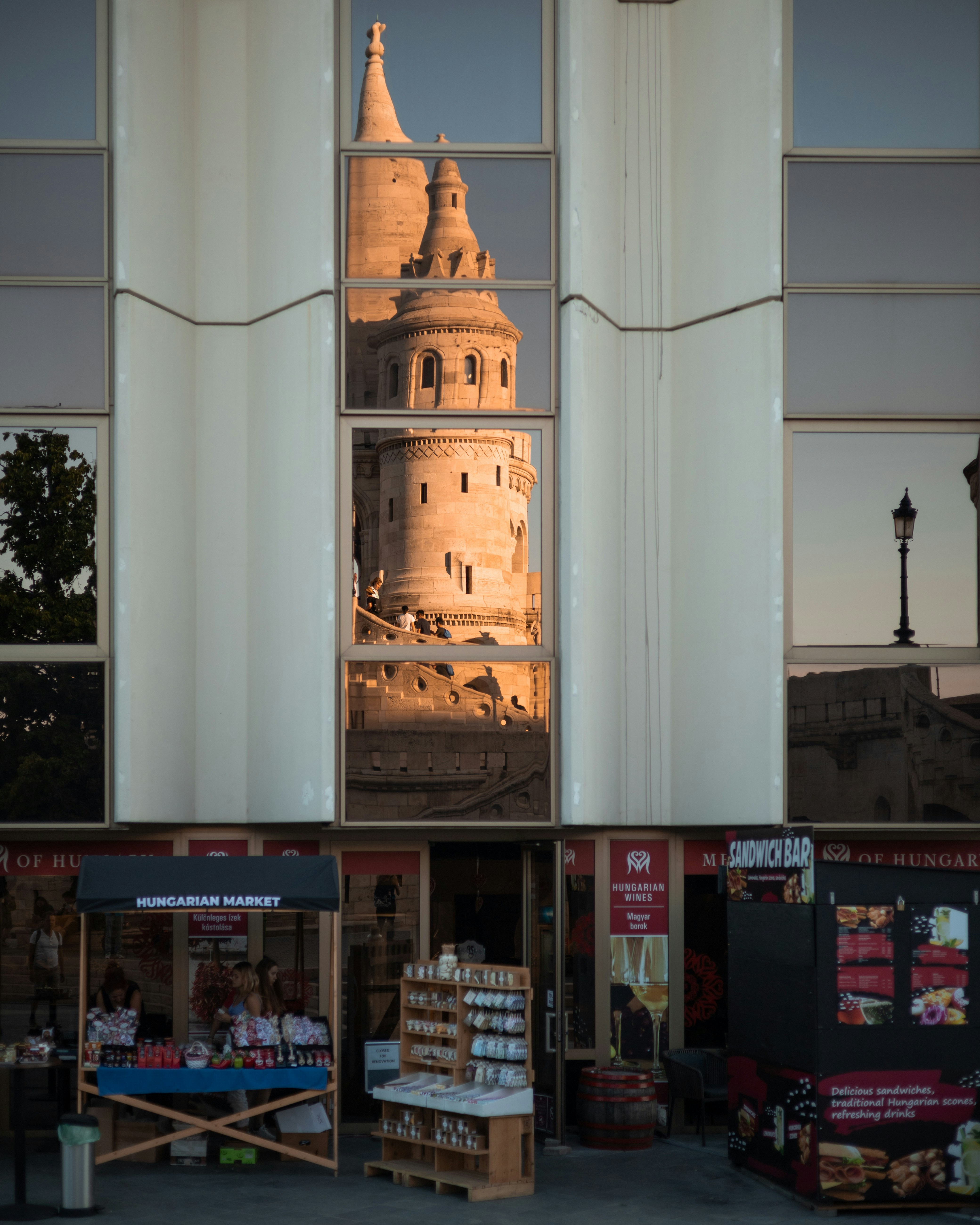 Tower Reflection in Glass: A Stroll Past the Market