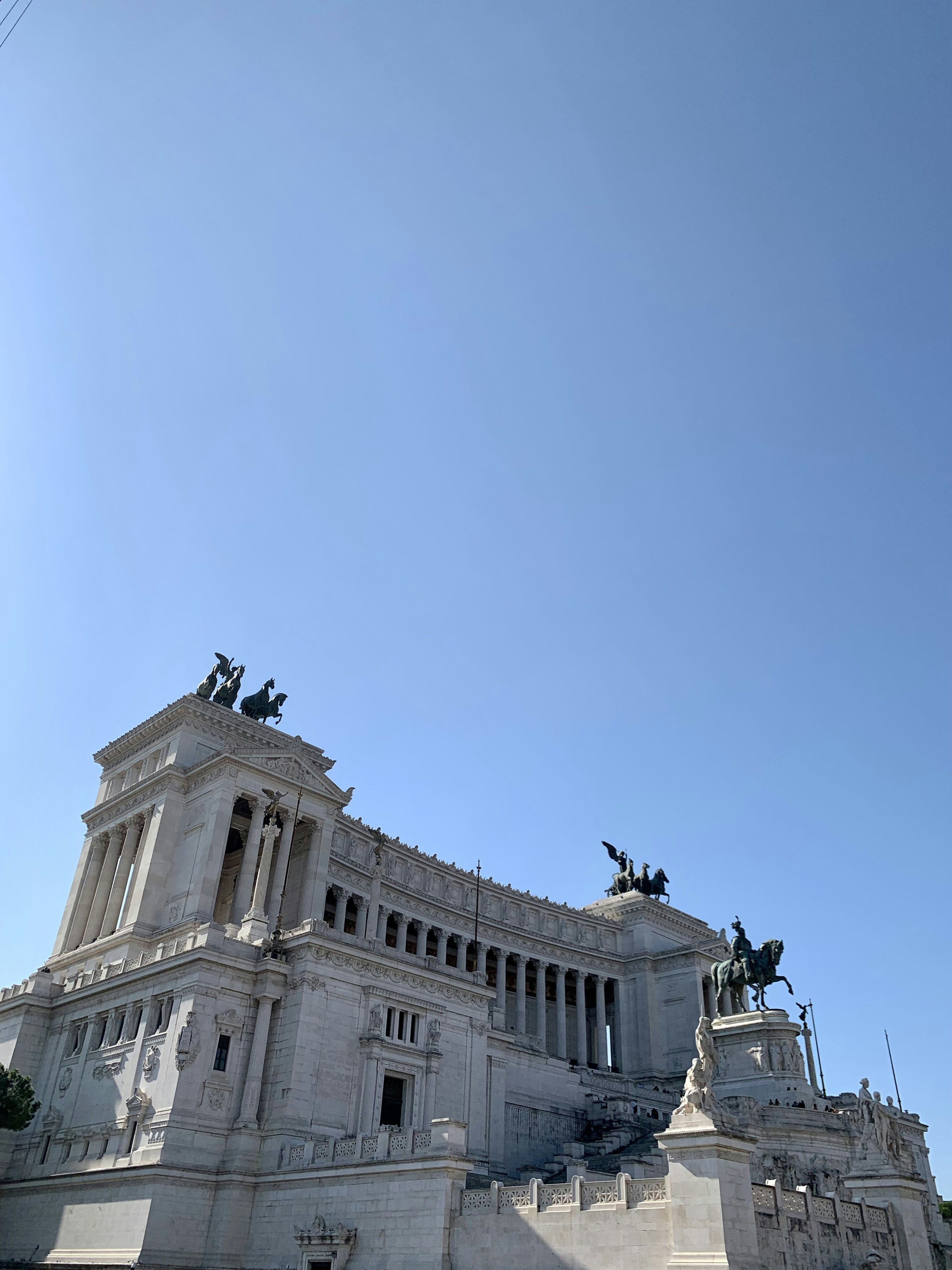 A building with statues on top photo – Free Blue Image on Unsplash