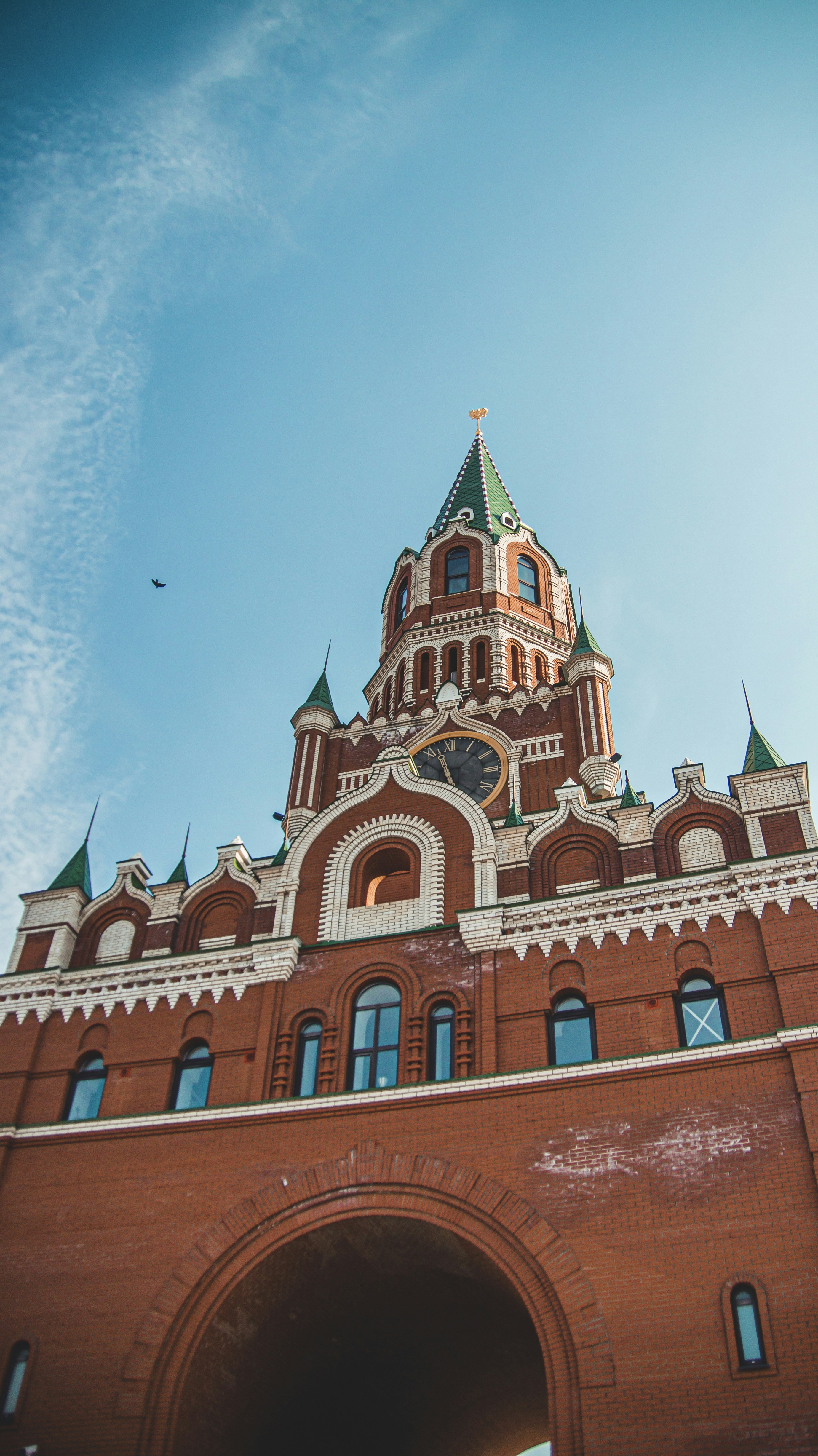 Gothic Revival Clocktower Rises Over Brick Arch