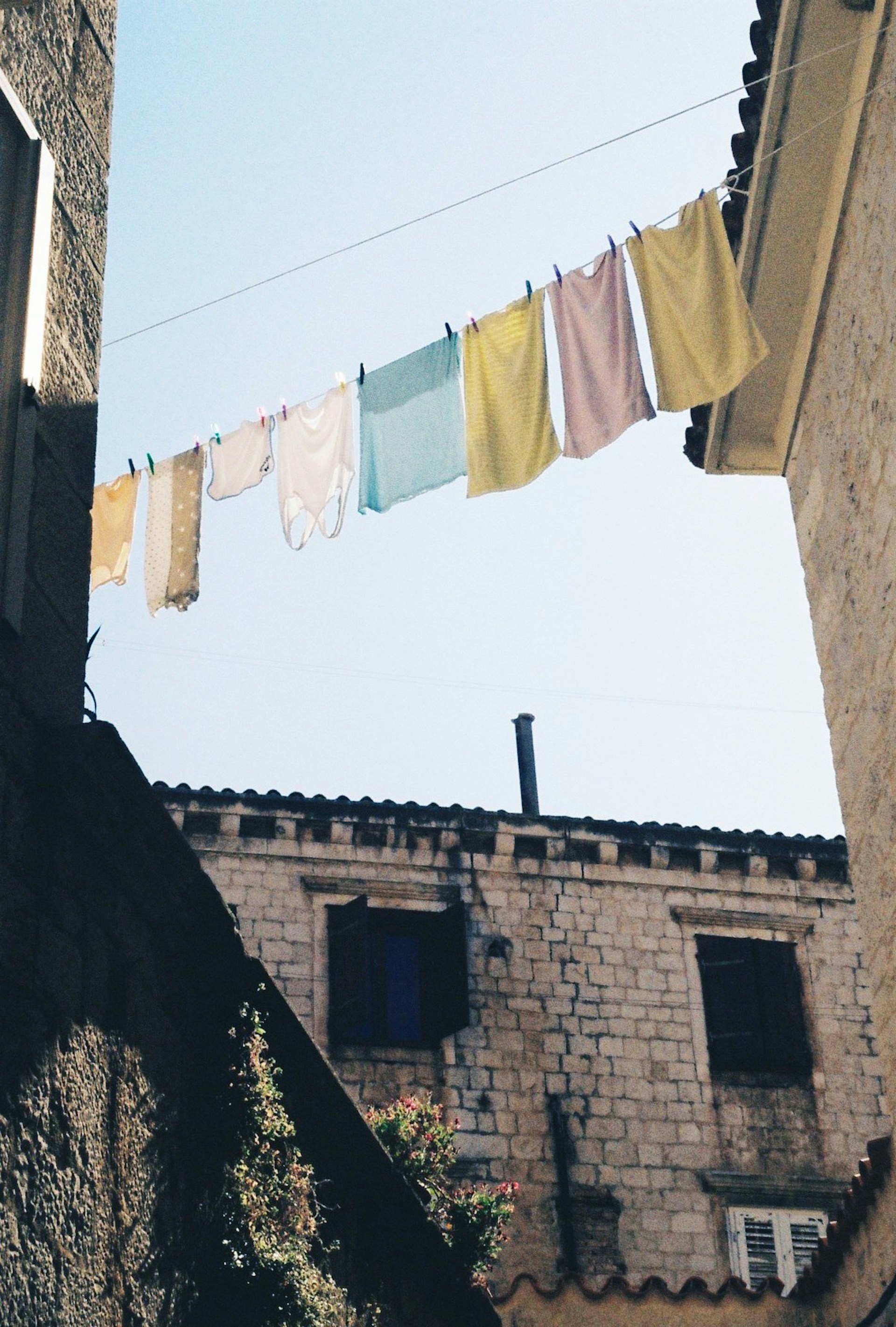 A line of clothes on a line outside of a building photo – Free Croatia ...