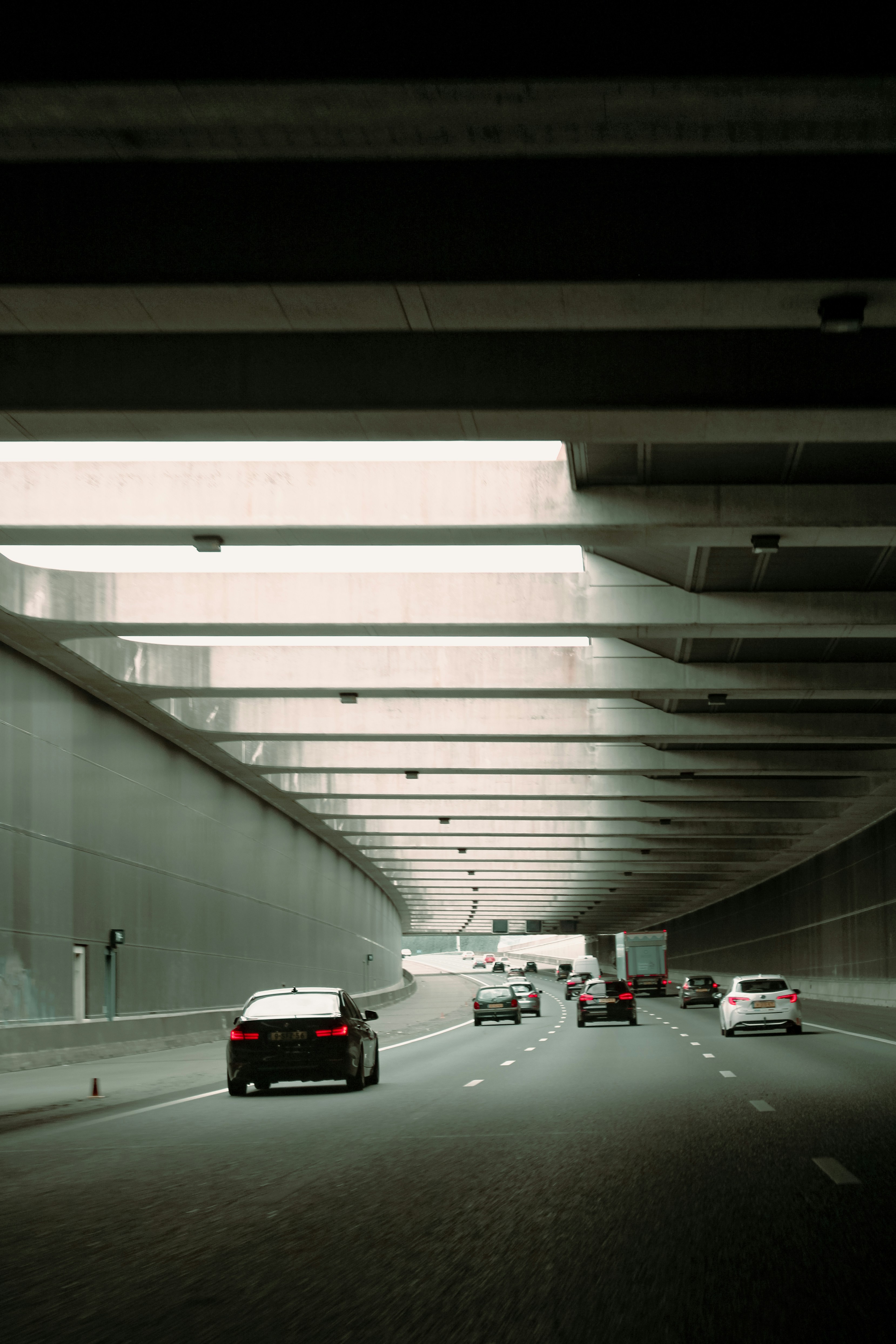 Cars driving under a bridge photo – Free Netherlands Image on Unsplash
