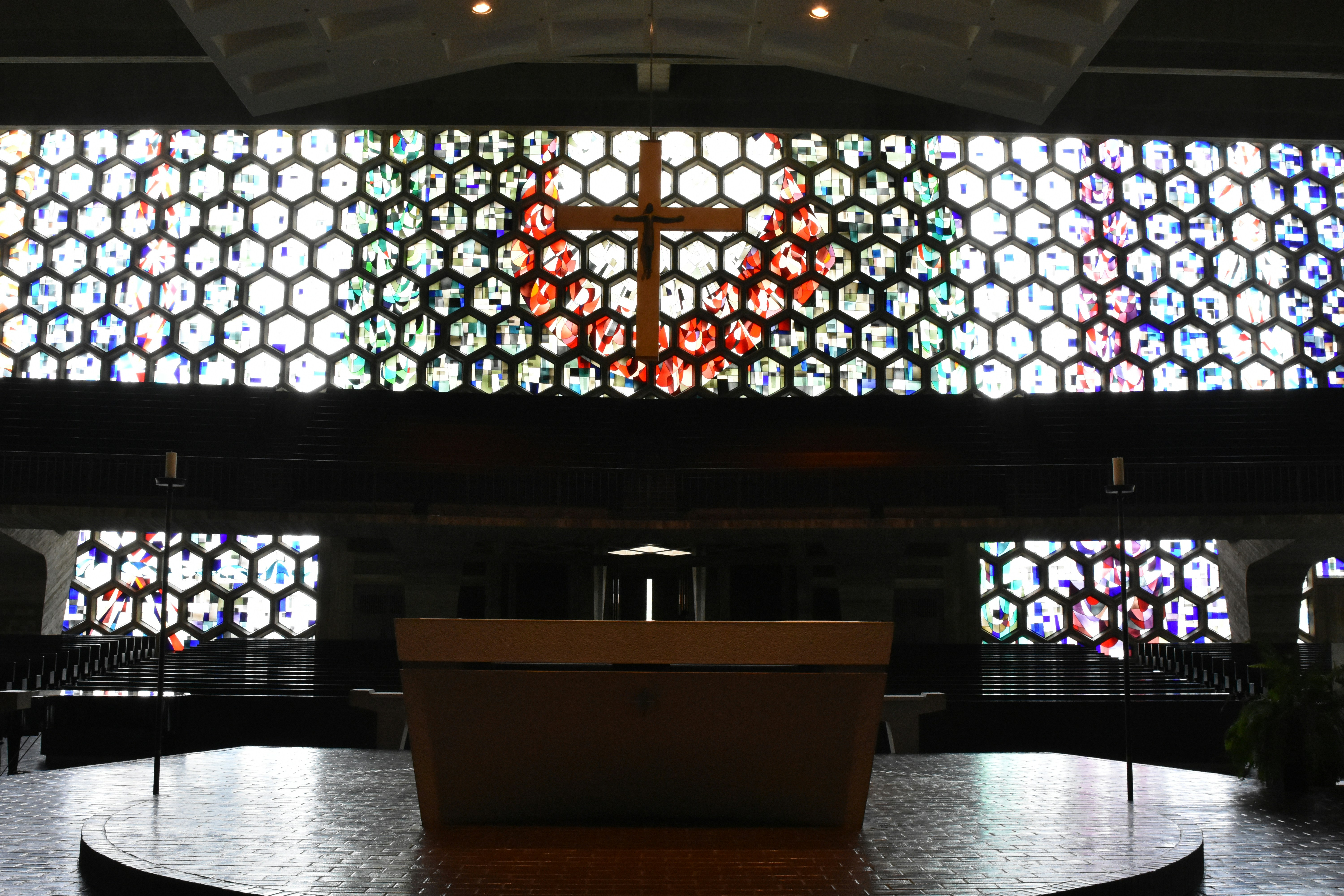 Altar Beneath a Hexagonal Halo: Cross Framed by Circular Stained Glass