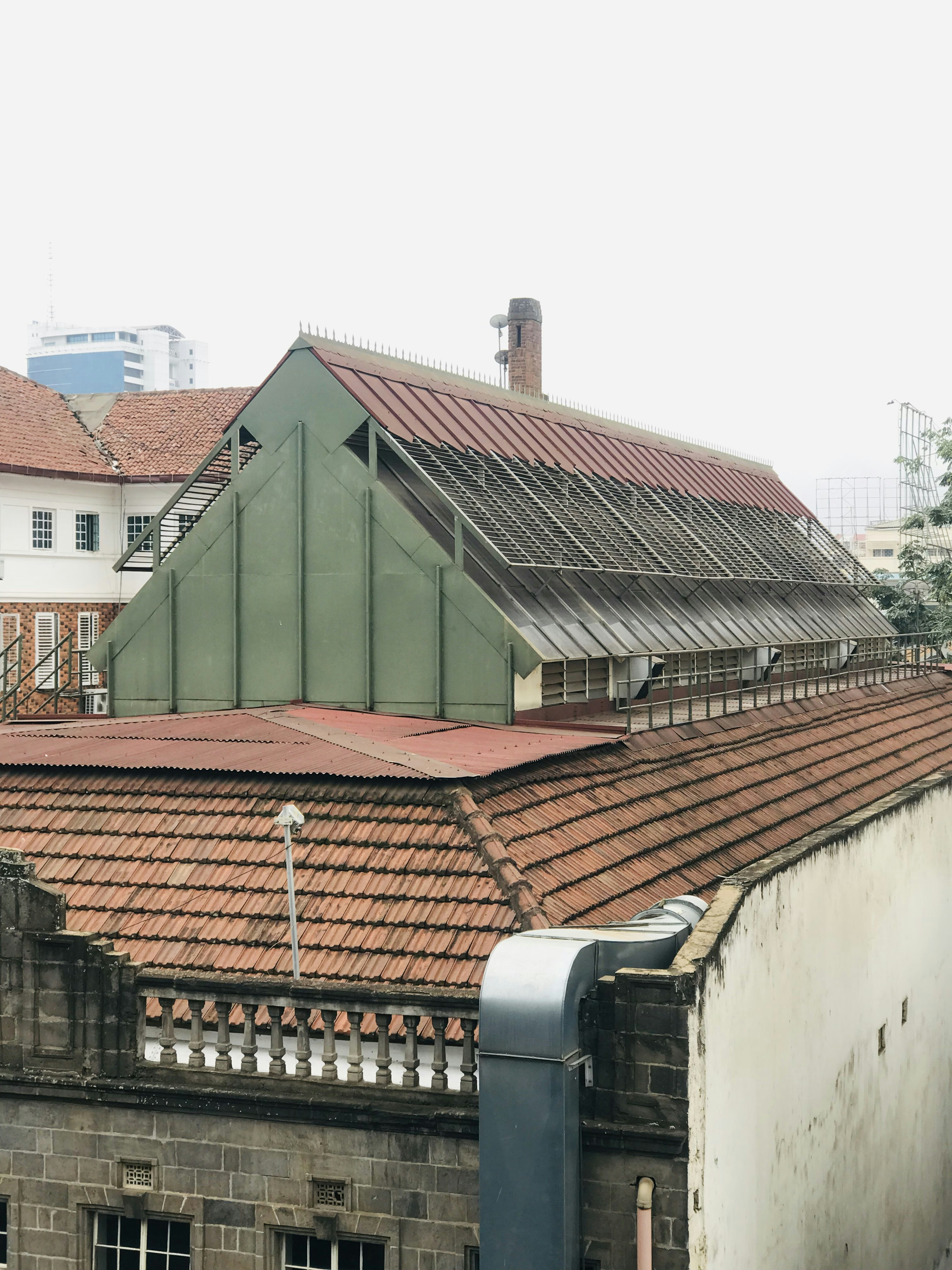 Green Gable Over a Red Tile City Roofscape