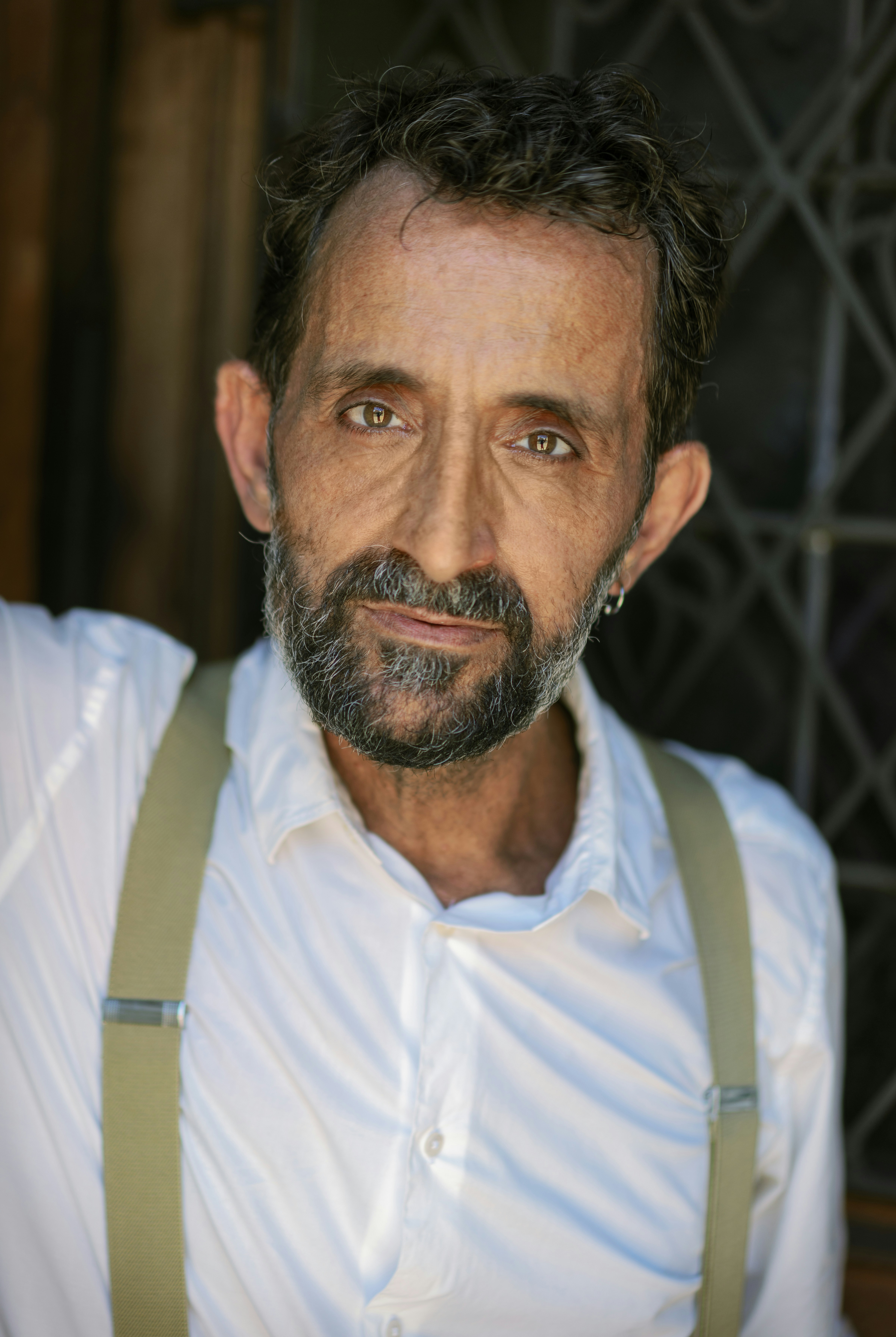 Gaze in Soft Light: Bearded Portrait in White Shirt and Suspenders