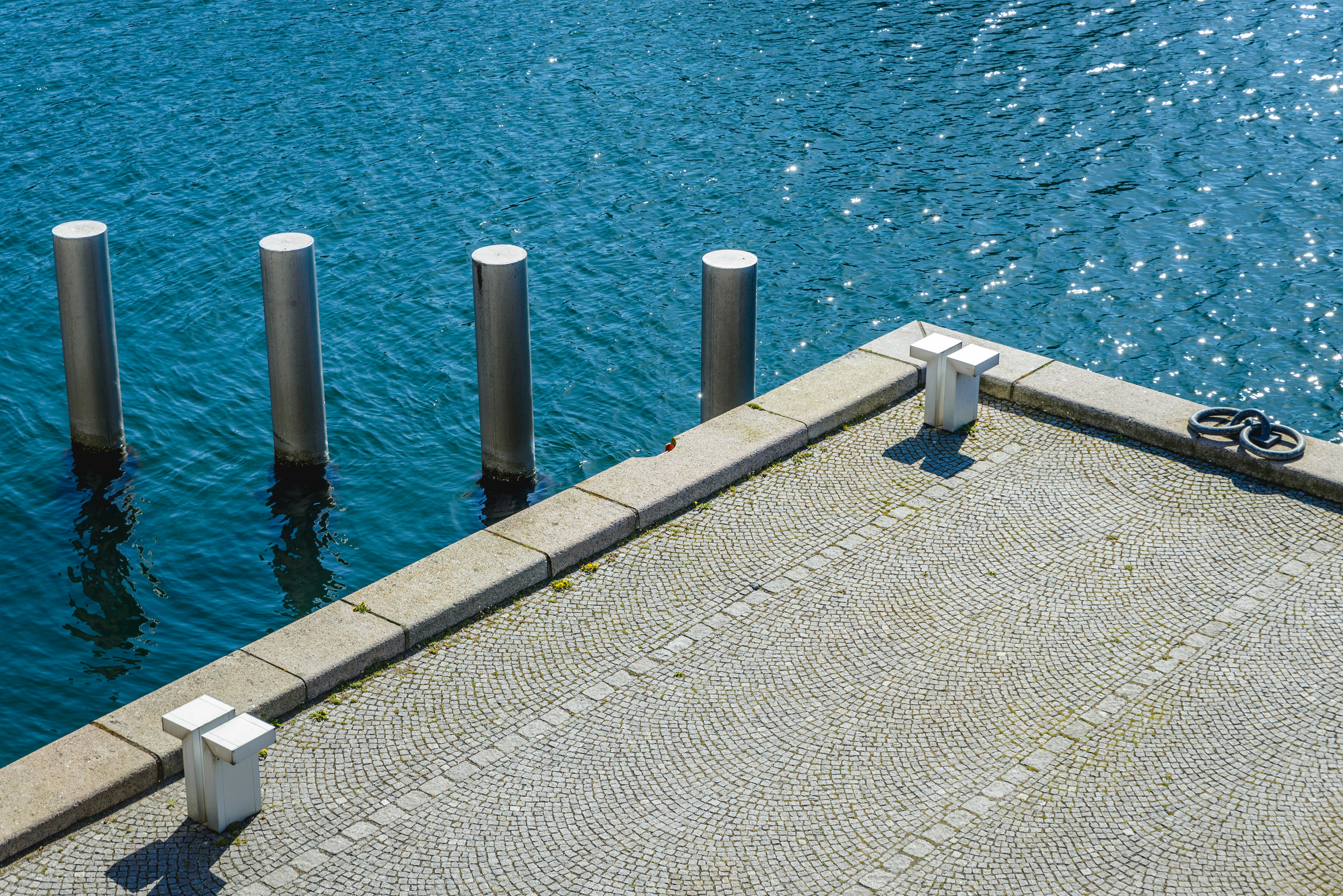 Turquoise Waterfront, Four Mooring Posts, and a Quiet Pierline