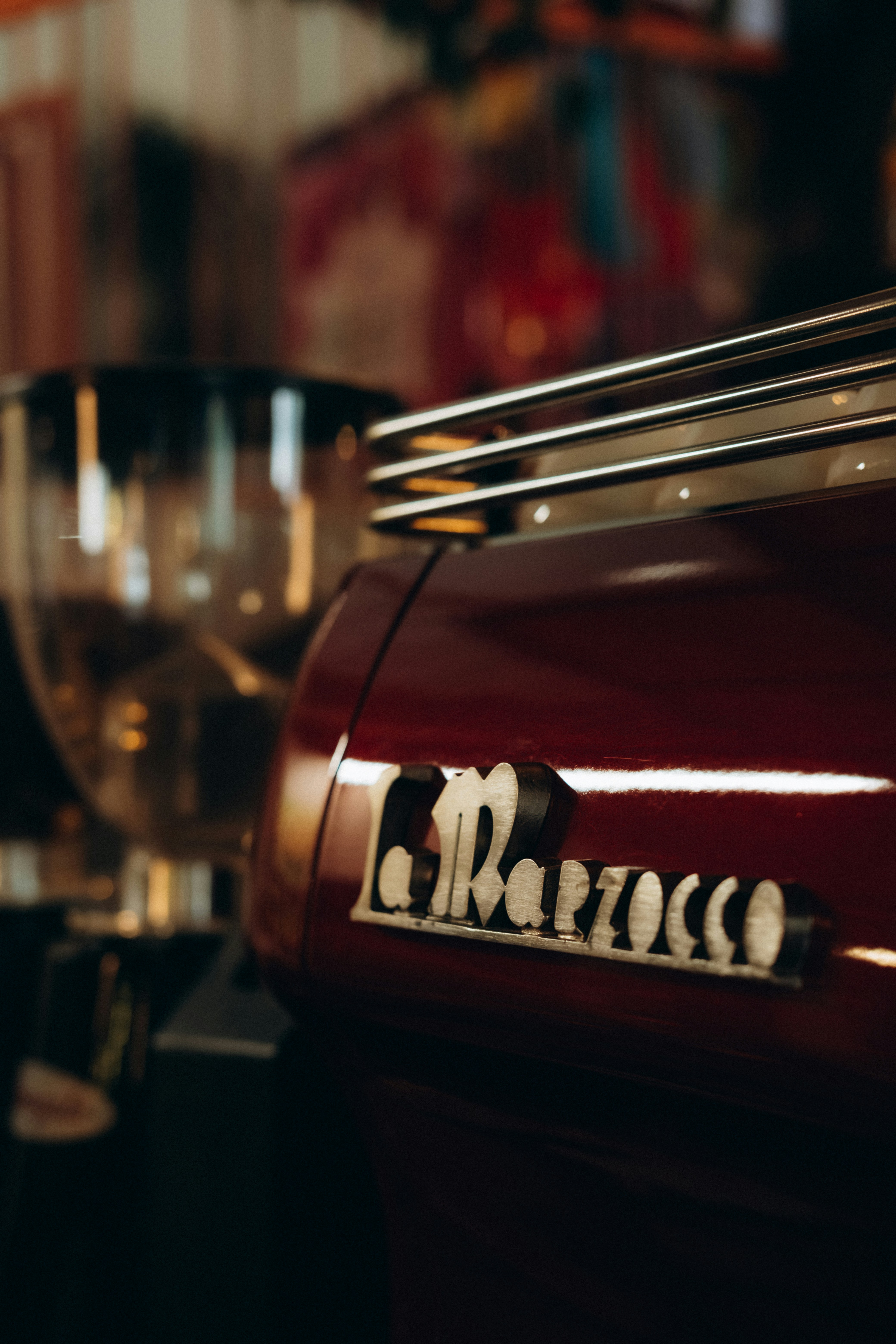 Dodge Coronet Emblem Bathed in Warm Chrome Light on a Red Classic