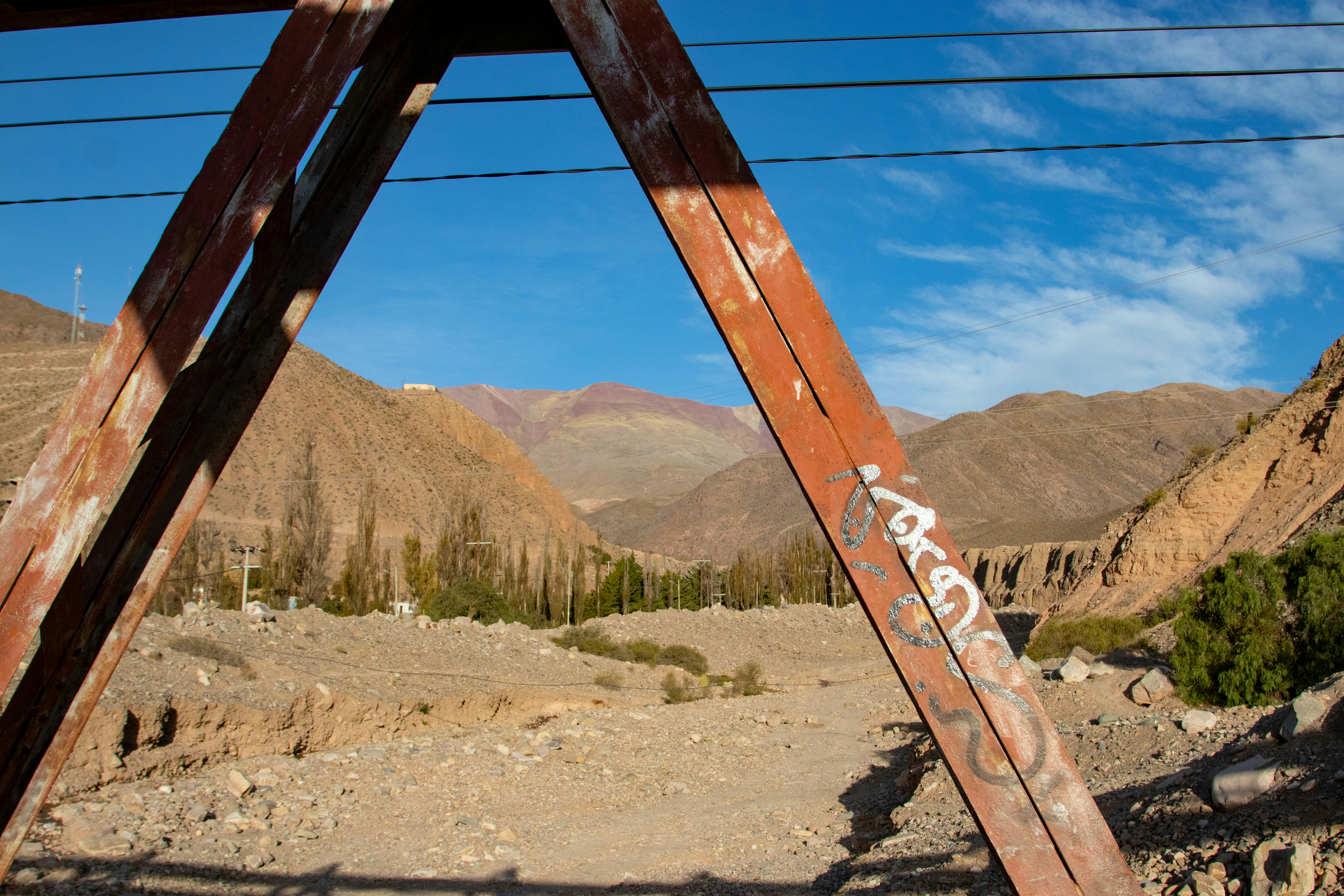 Rusted Iron Arch Framing a Desert Horizon