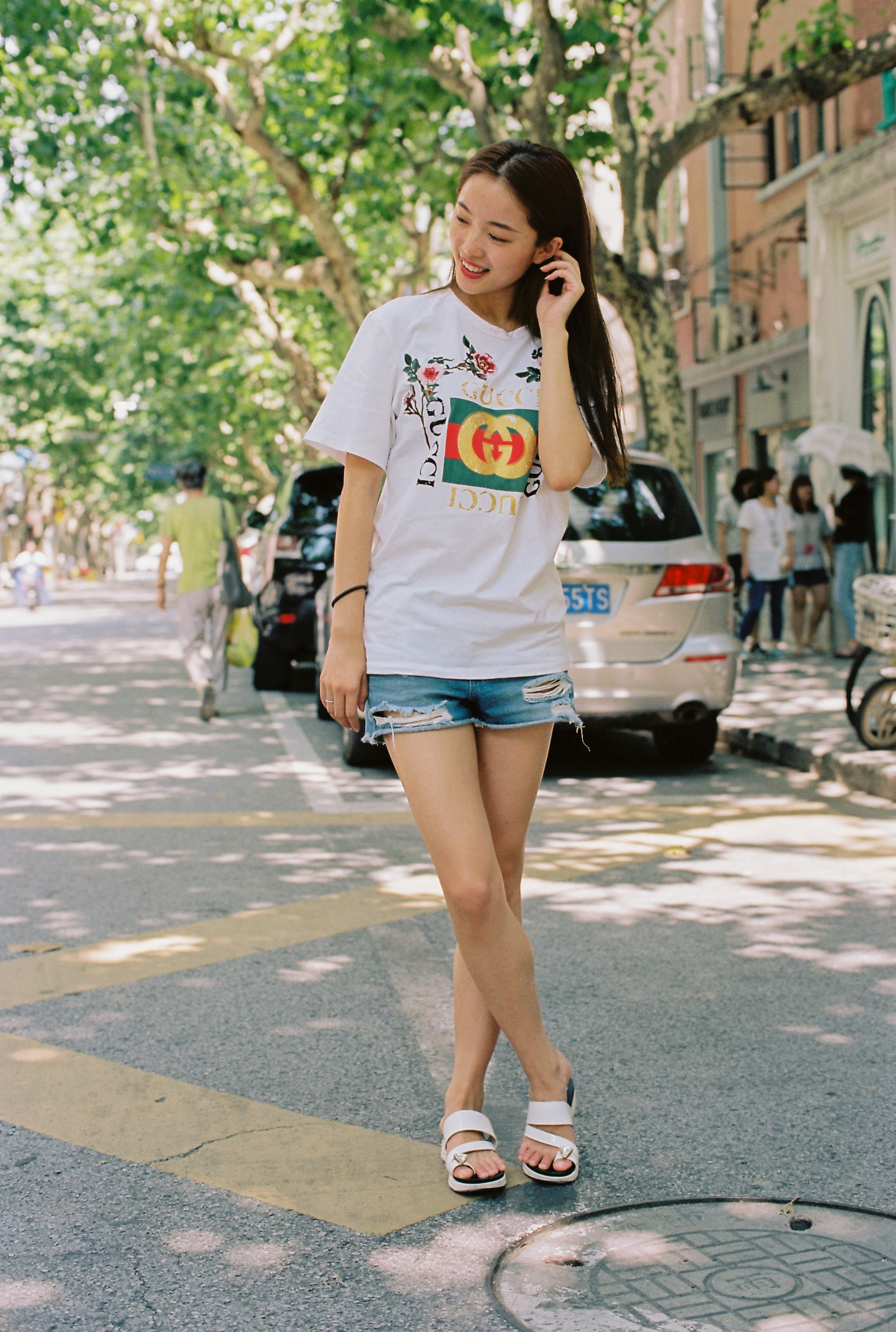Street Confidence: A Sunlit Moment with a Casual Gucci Tee