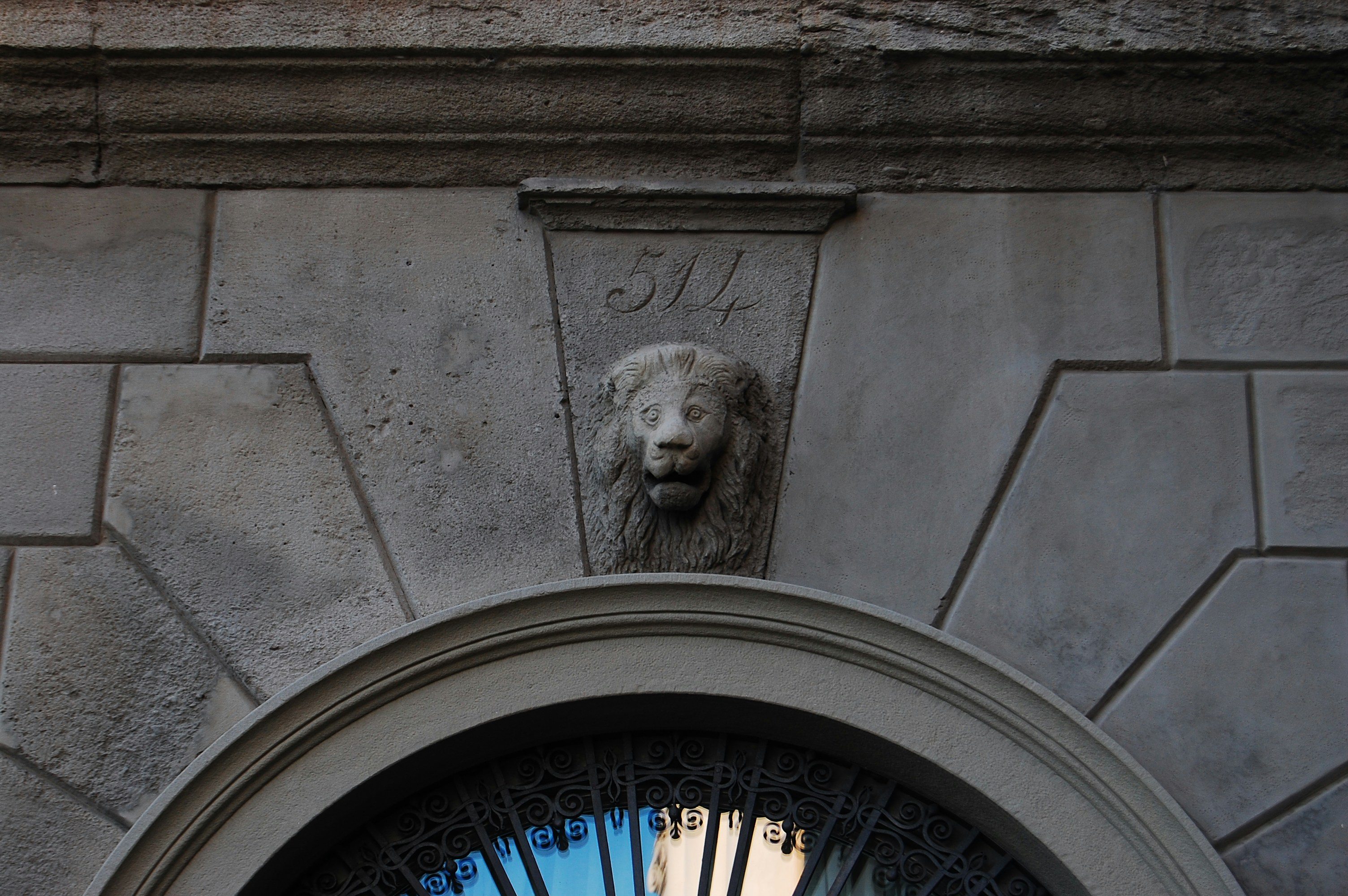 A lion decoration below a gate, Bergamo, Italy