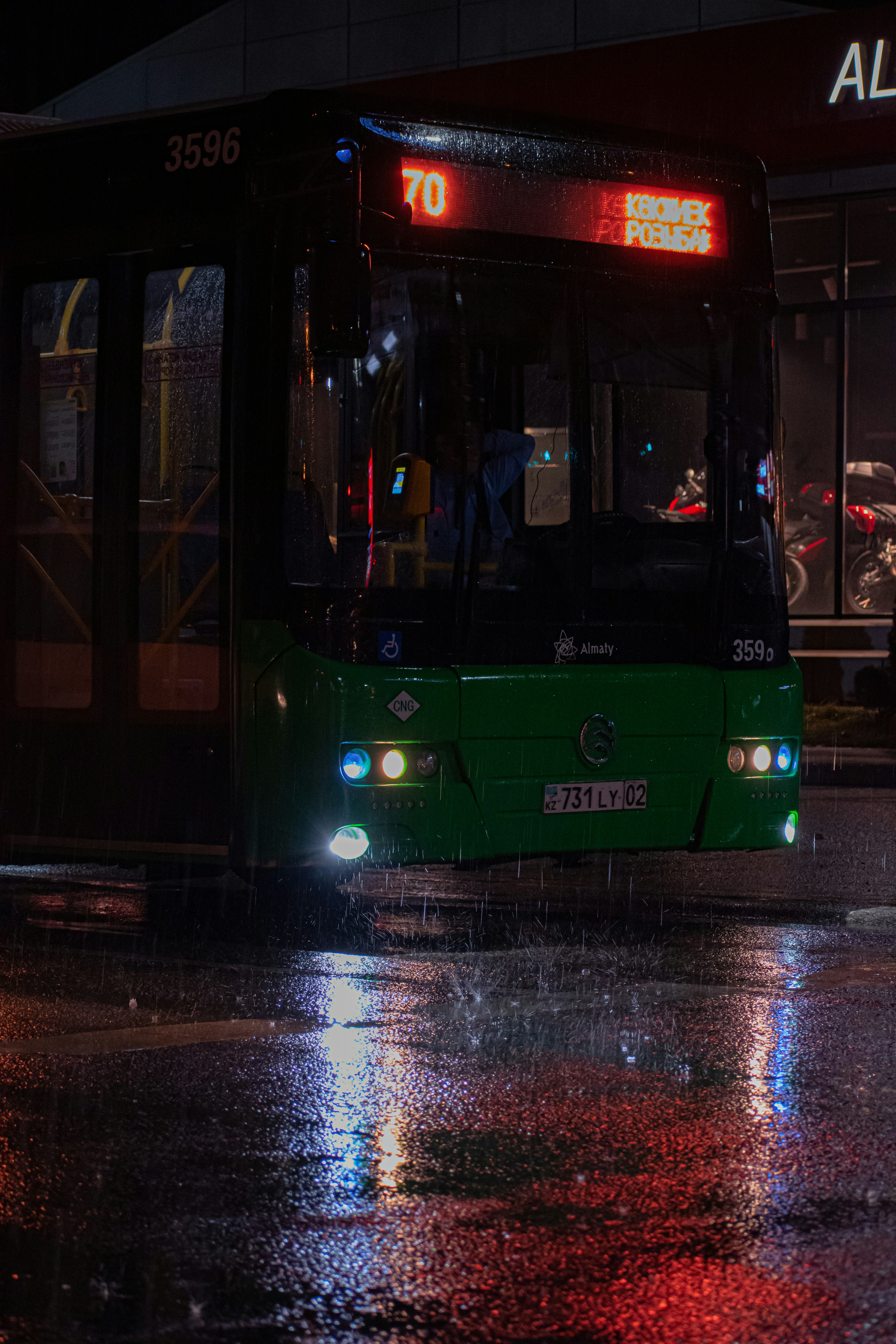 Night Ride: Glowing Busfront in Rain