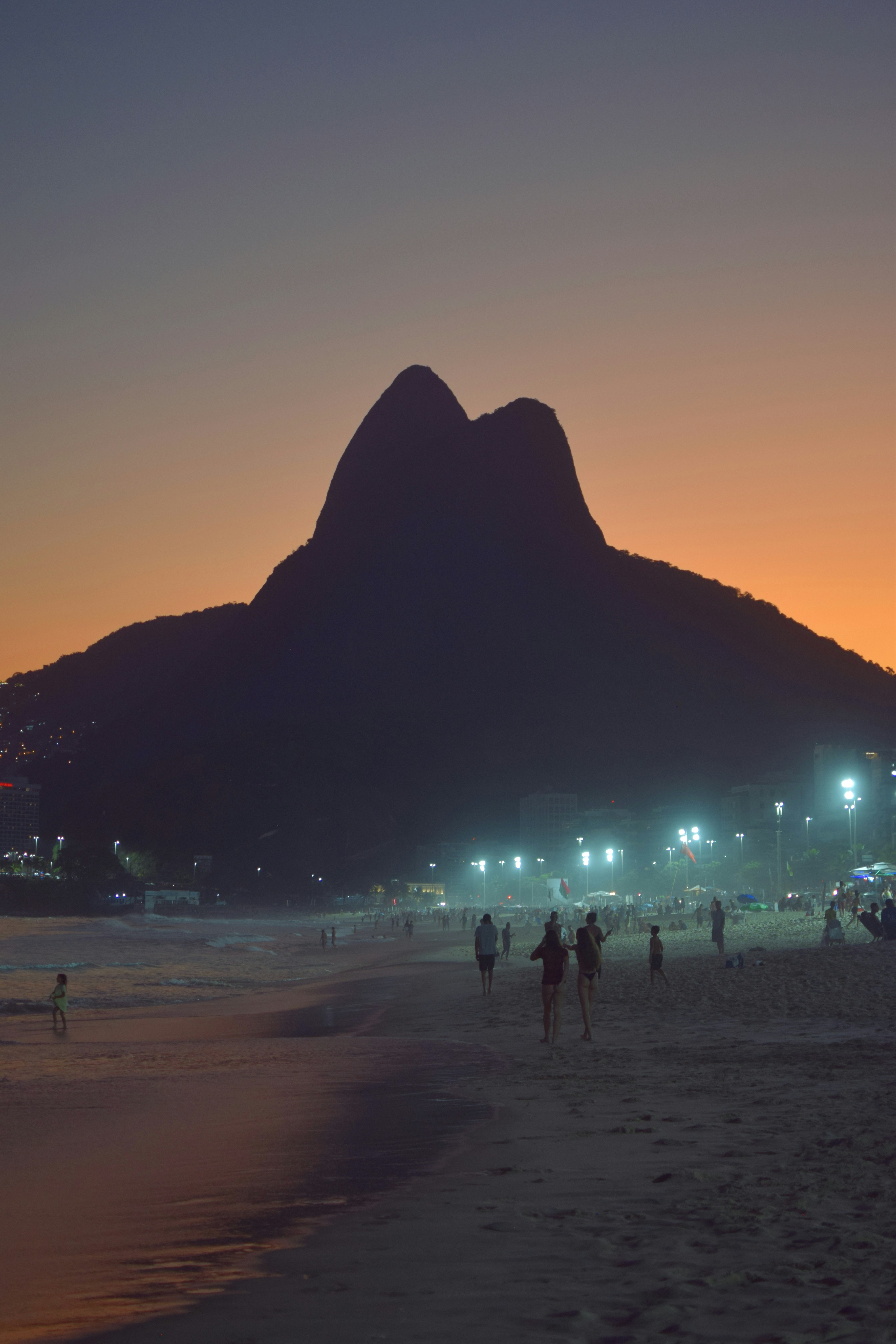 Twin Peaks at Sunset: Silhouette Over a Neon-Glow Beach