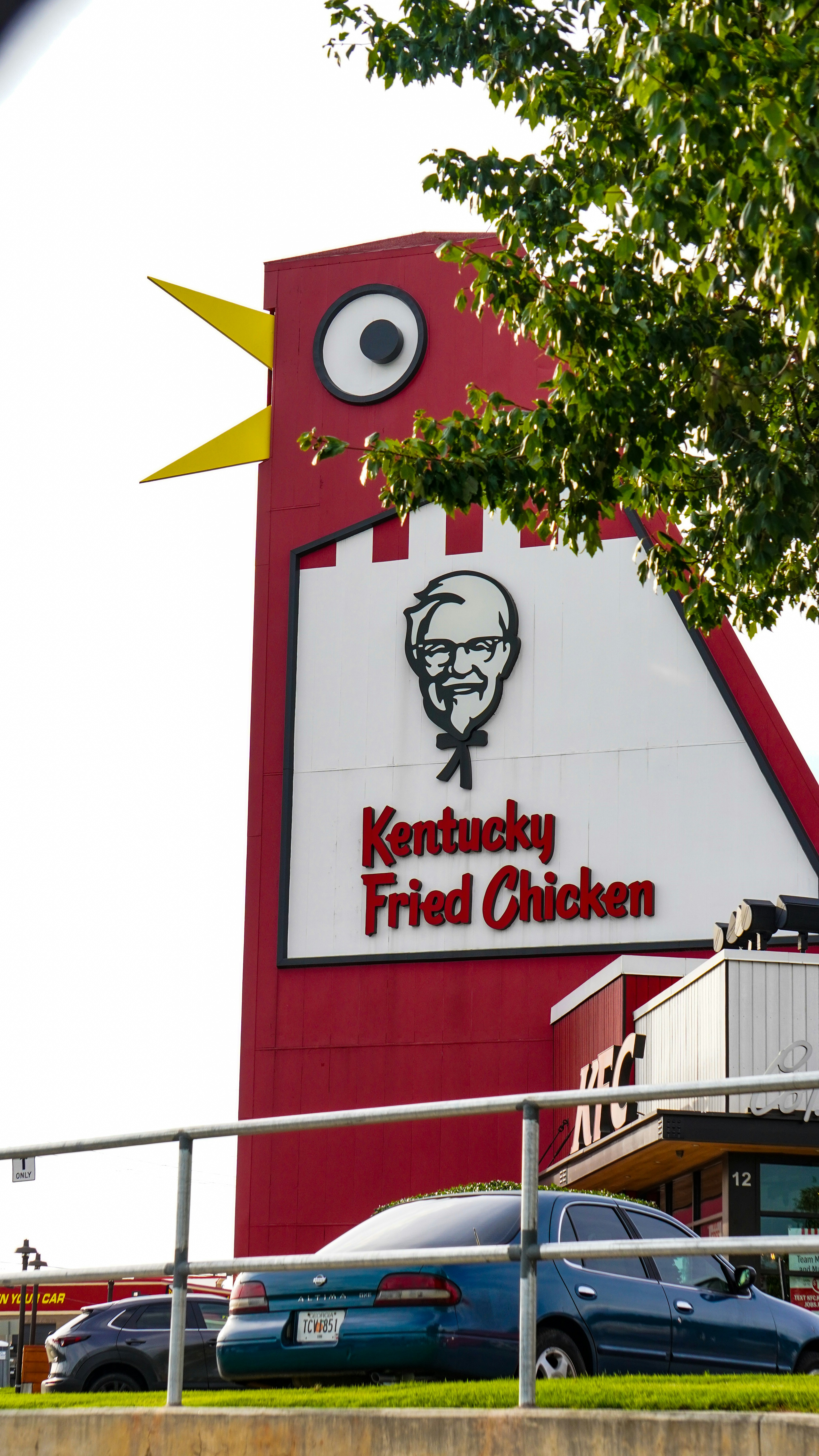 KFC Signage Rising over a Parked Car