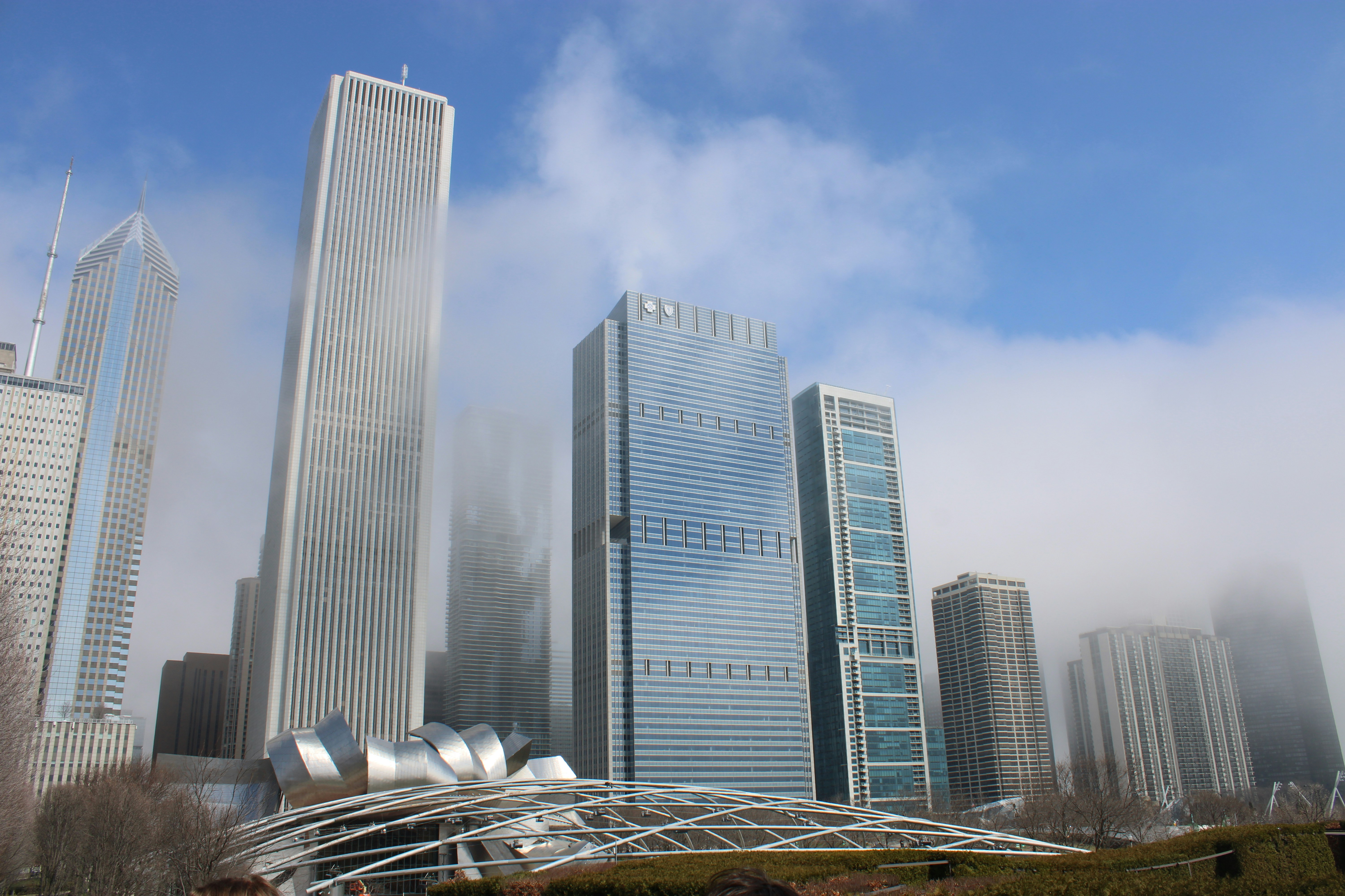Mist-Clad Giants: A Modern Skyline Emerging Through Clouds