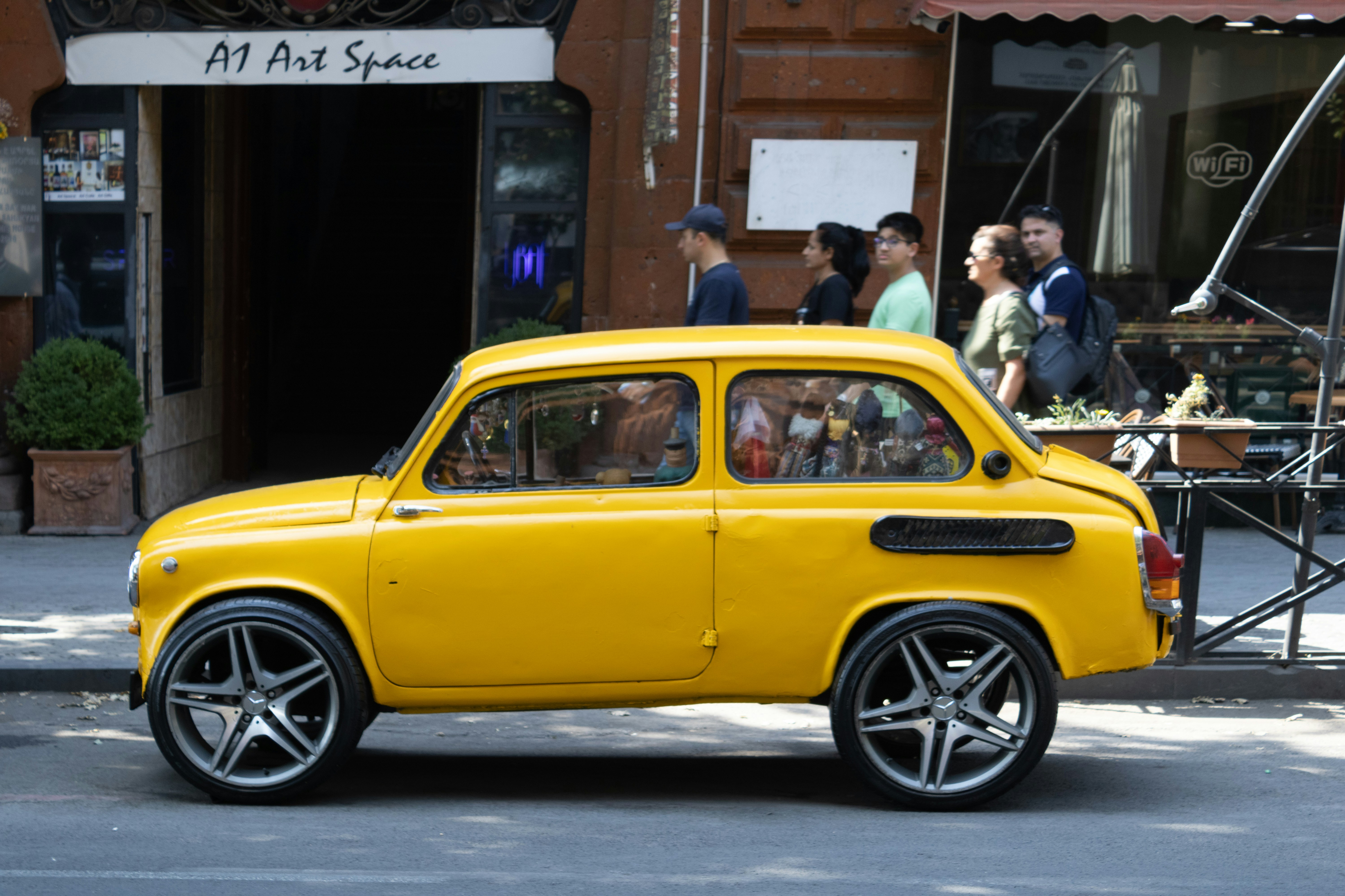 Urban Vintage: Yellow Classic Amidst the Modern Cityscape