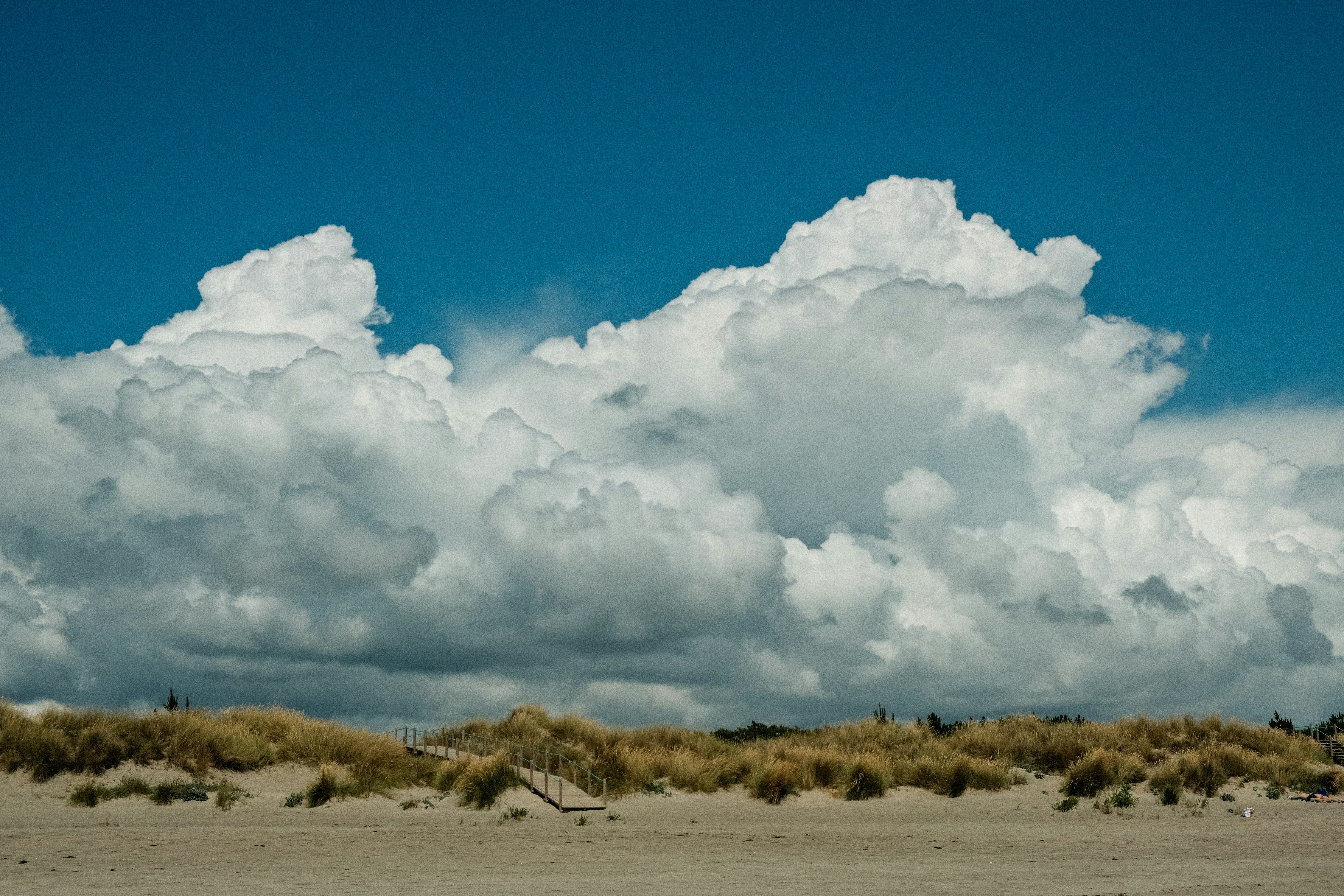 Dune Stairway Beneath a Colossal Sky of Clouds