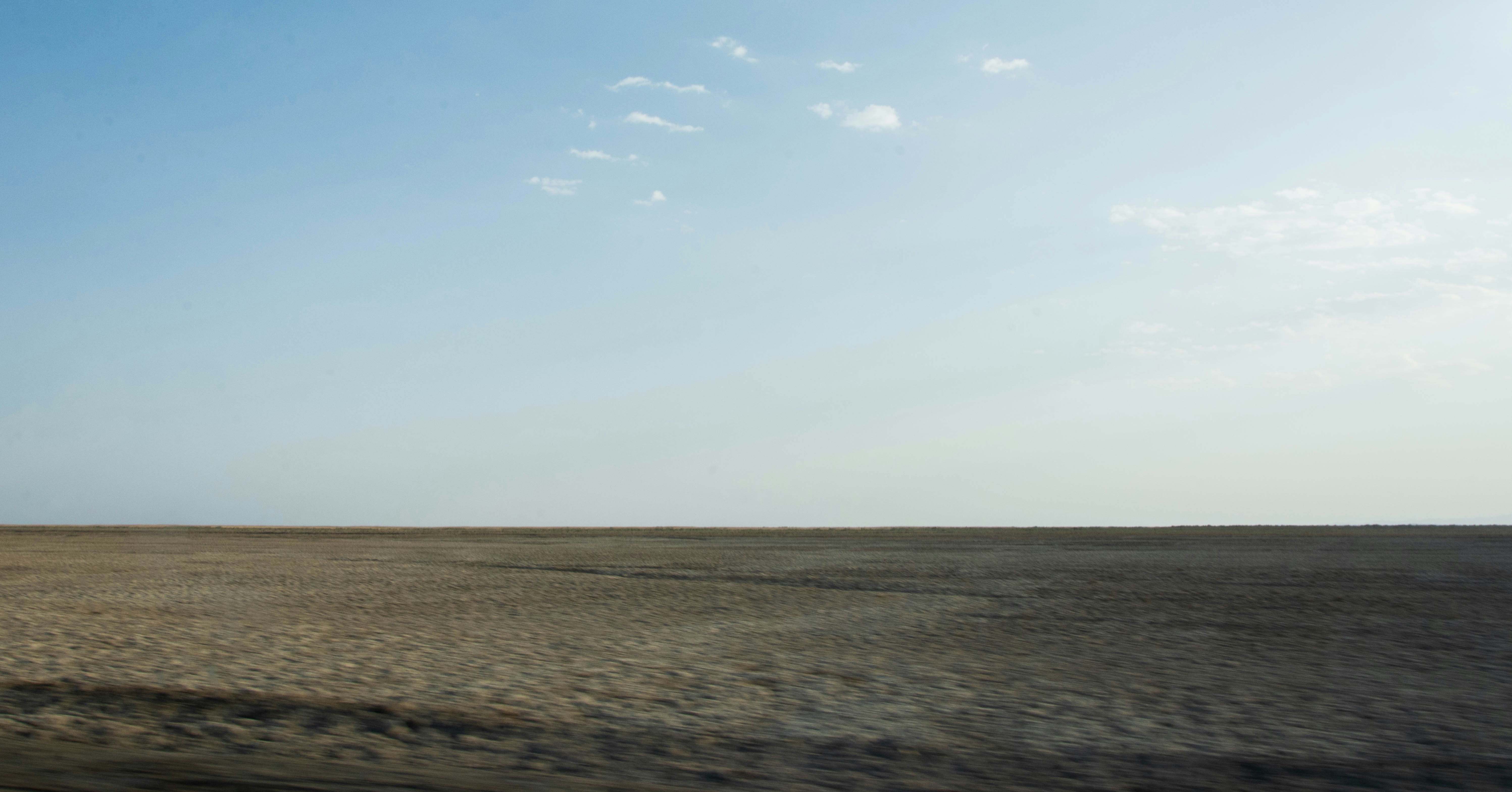 A large flat area with a blue sky photo – Free Gavkhuni wetland Image ...