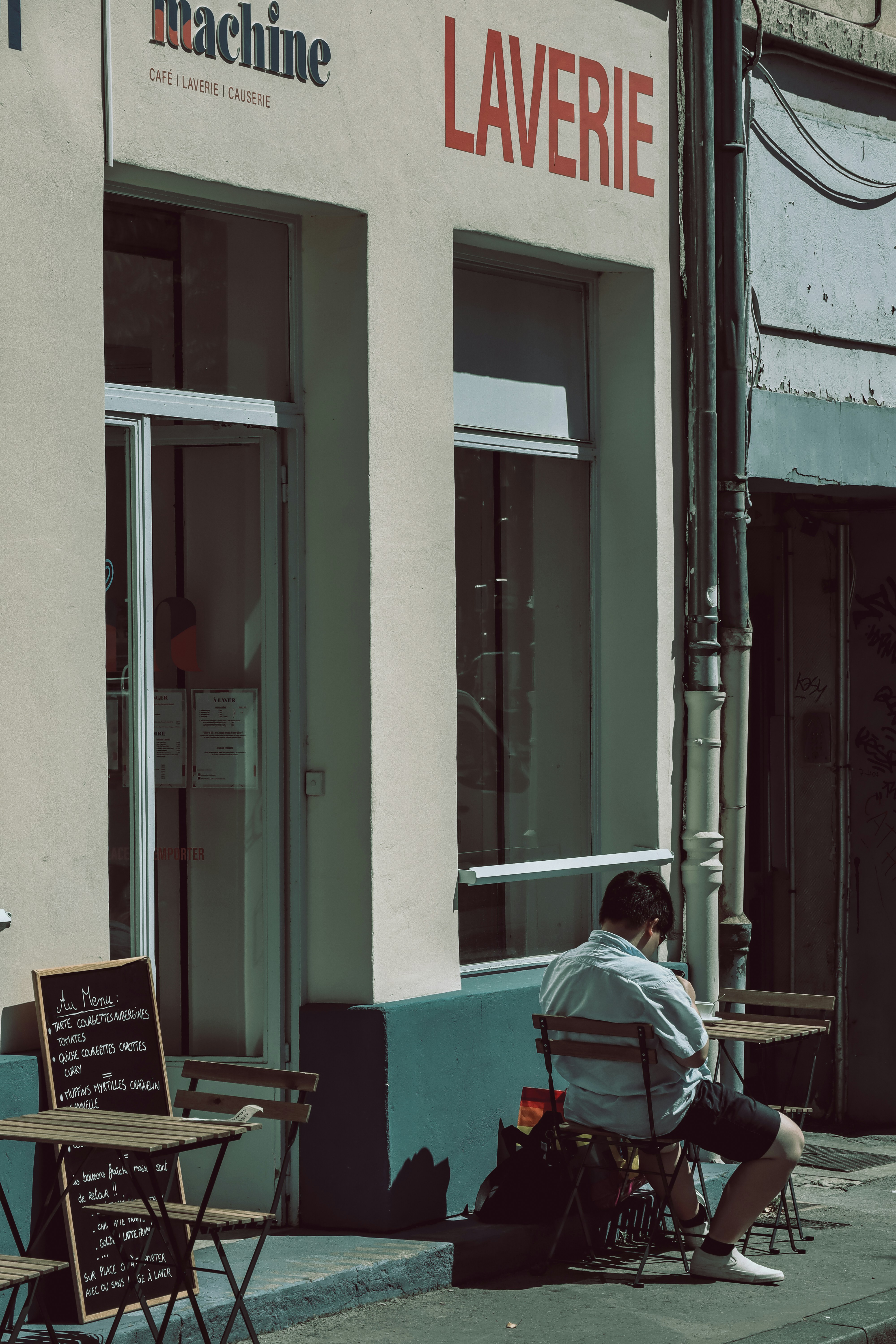 A person sitting outside a building photo – Free Lyon Image on Unsplash