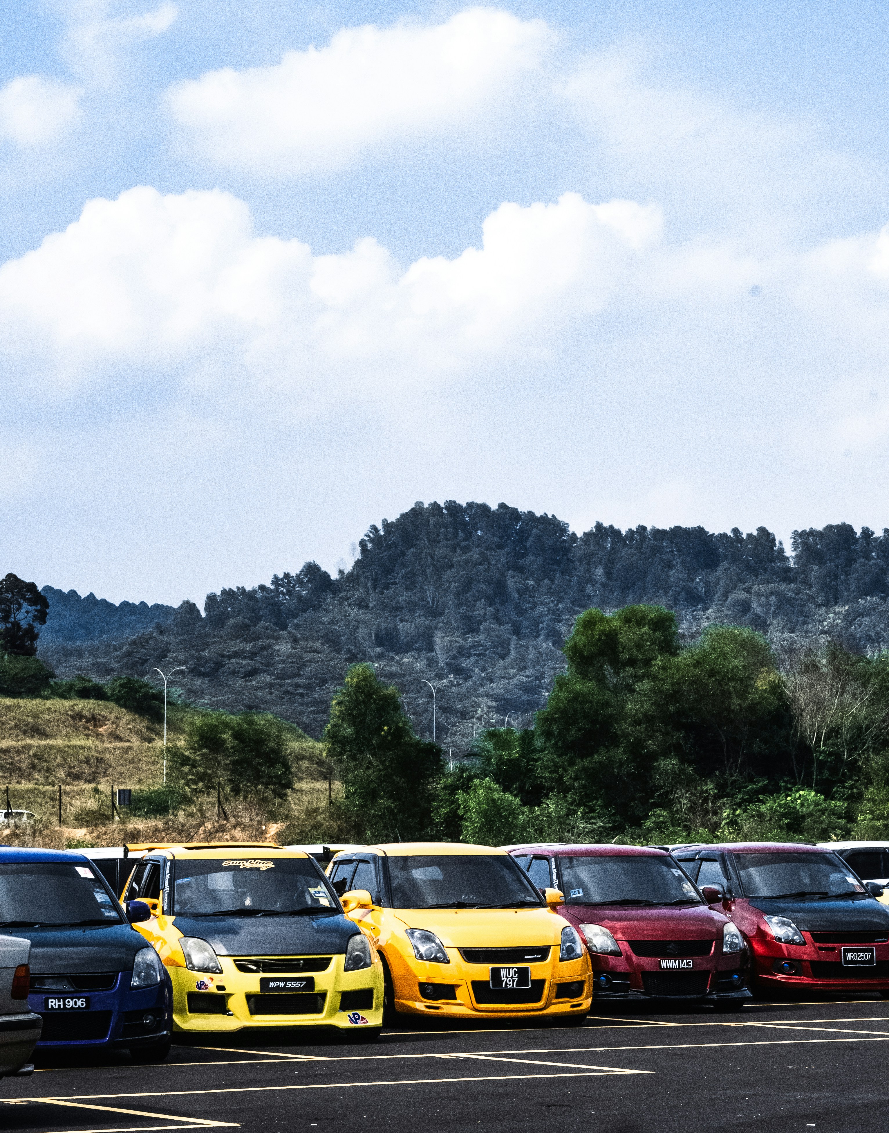 Sunny Standstill: A Kaleidoscope of Hatchbacks in a Quiet Parking Lot