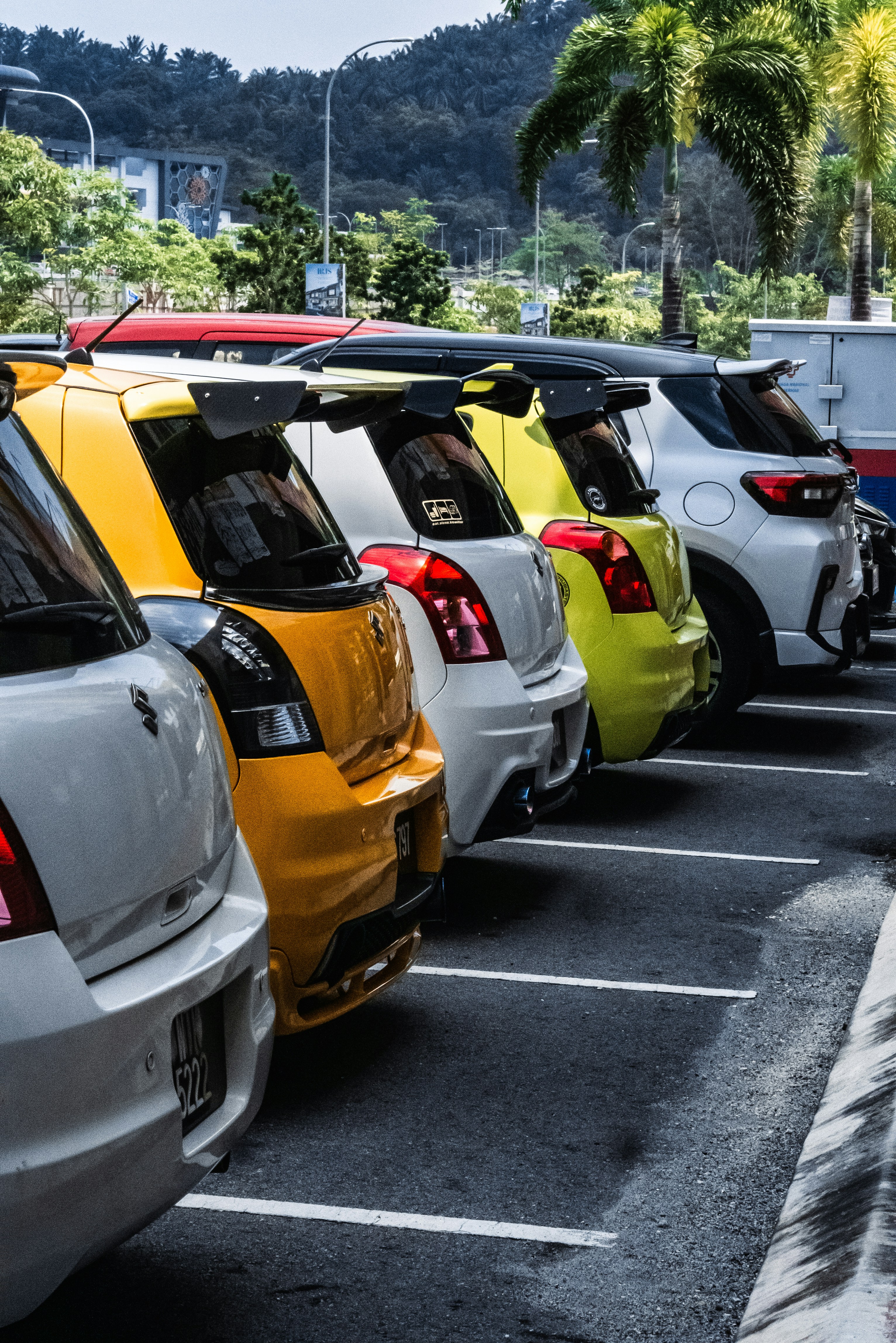 A group of cars parked in a parking lot photo – Free Automobile Image ...