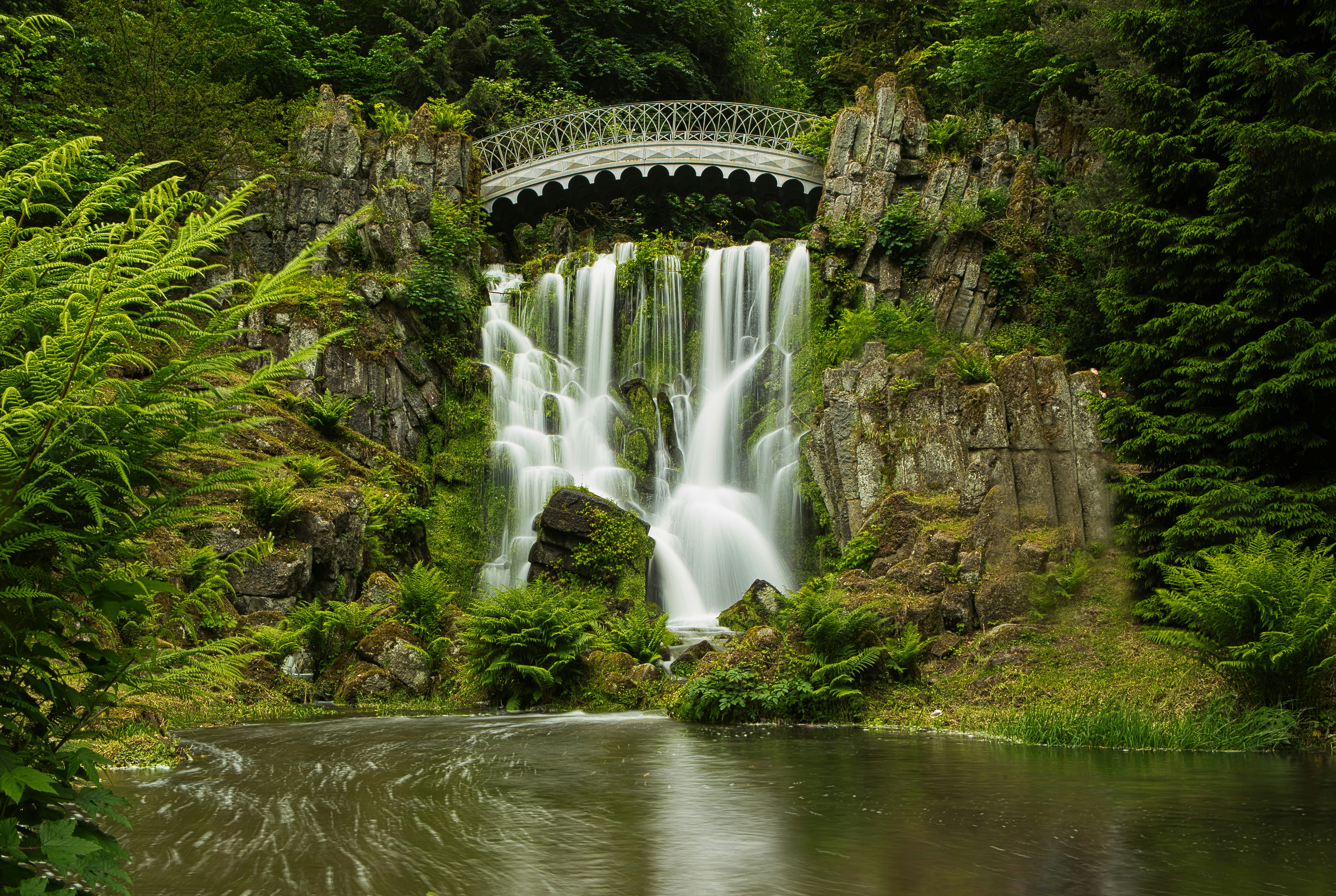 long exposure of a waterfall | a bridge over a waterfall