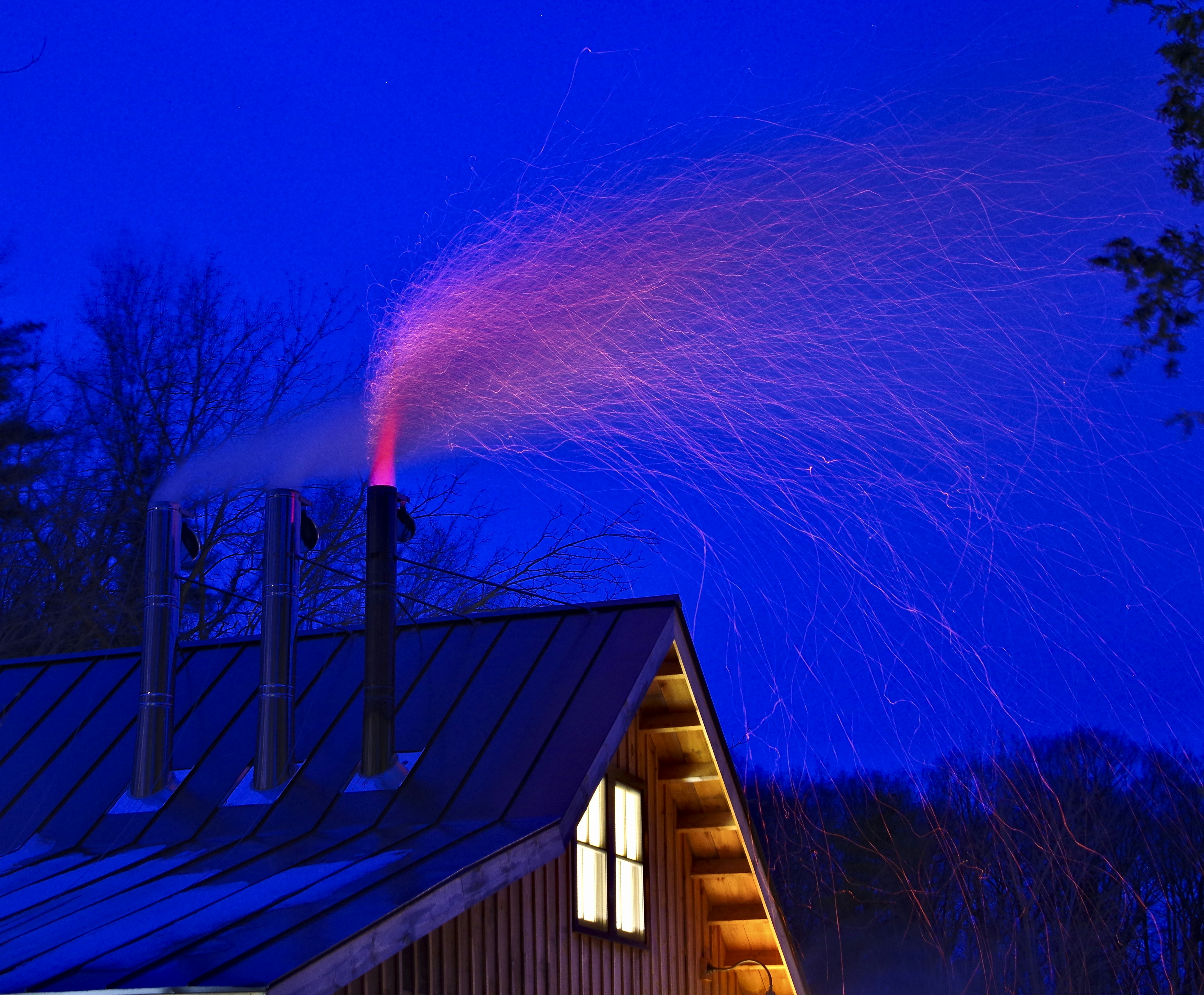 Smoke-tempered sparks above a cozy rooftop chimney