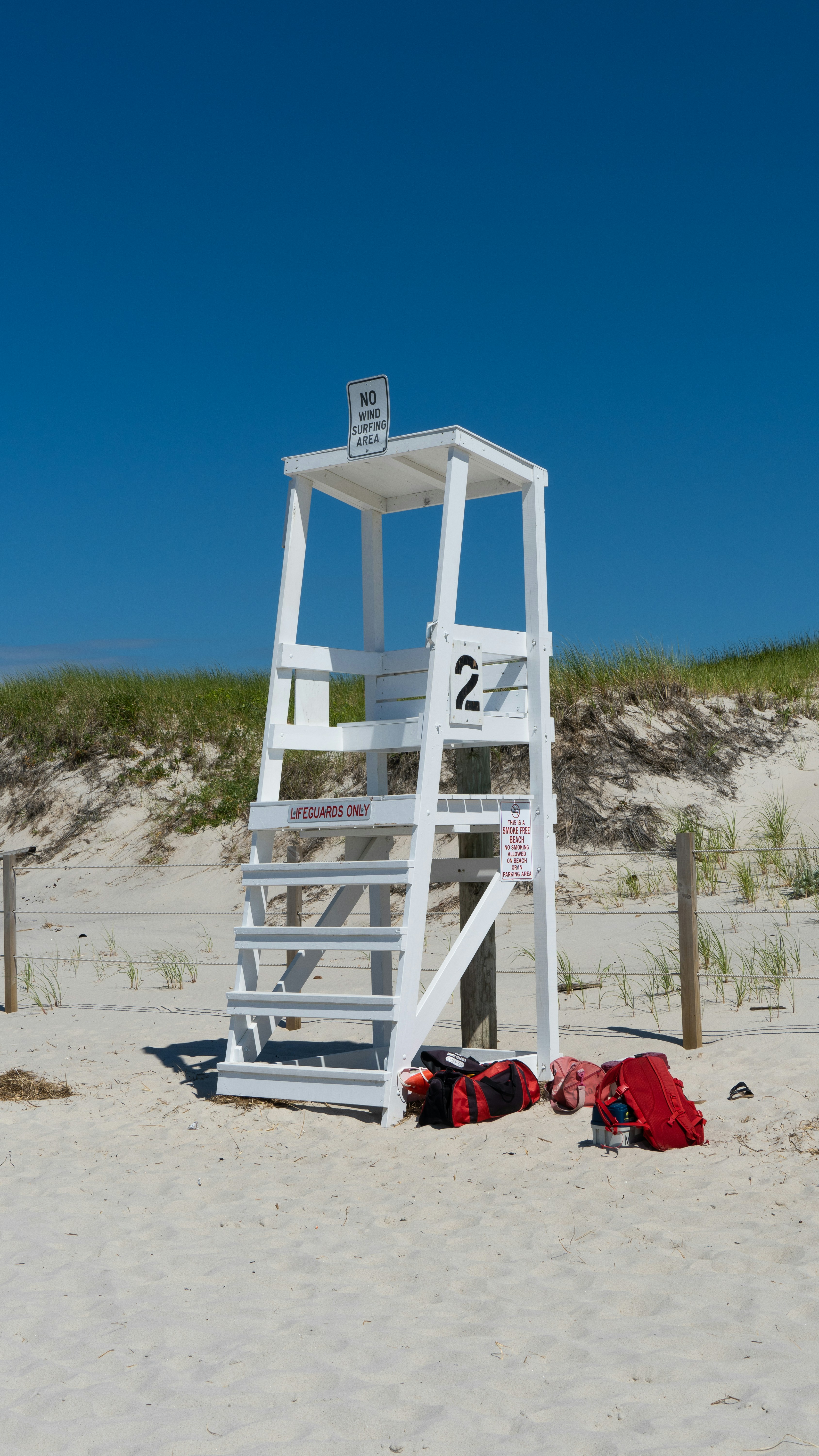 White Lifeguard Tower Under a Clear Blue Sky on a Quiet Beach