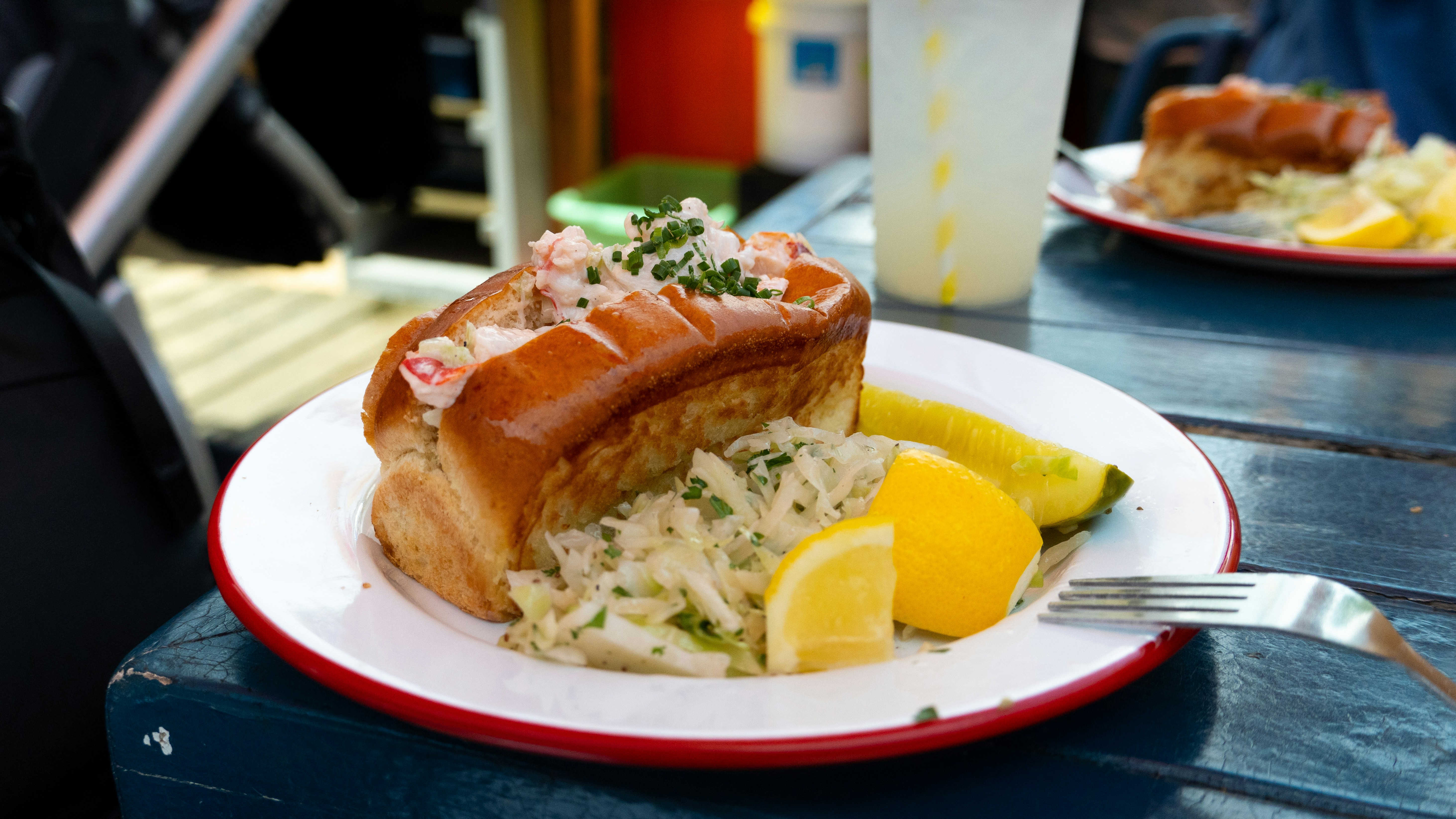 Herbed sausage perched atop creamy rice with lemon wedges in a sunlit café