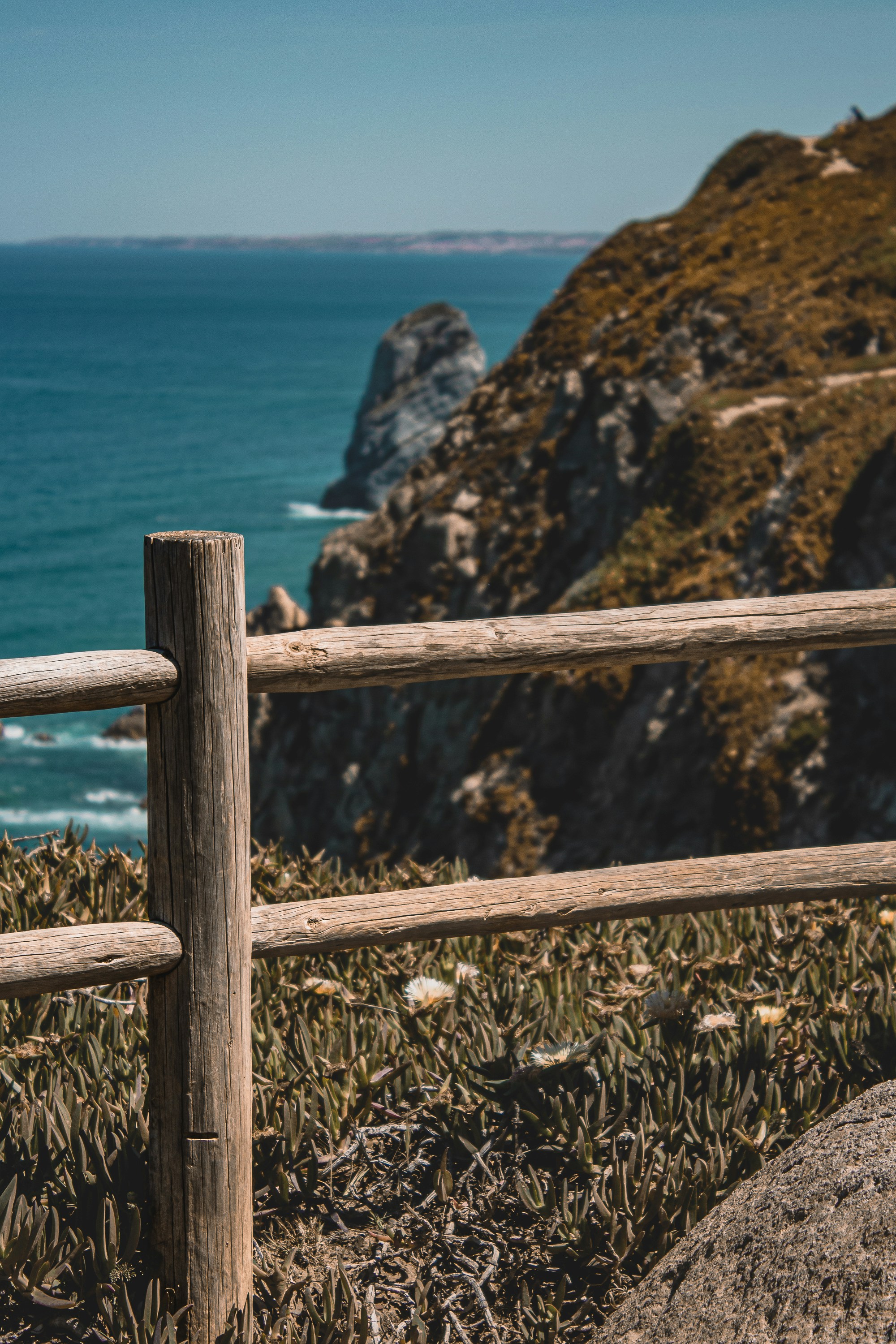 A wooden fence overlooking a body of water photo – Free Portugal Image ...