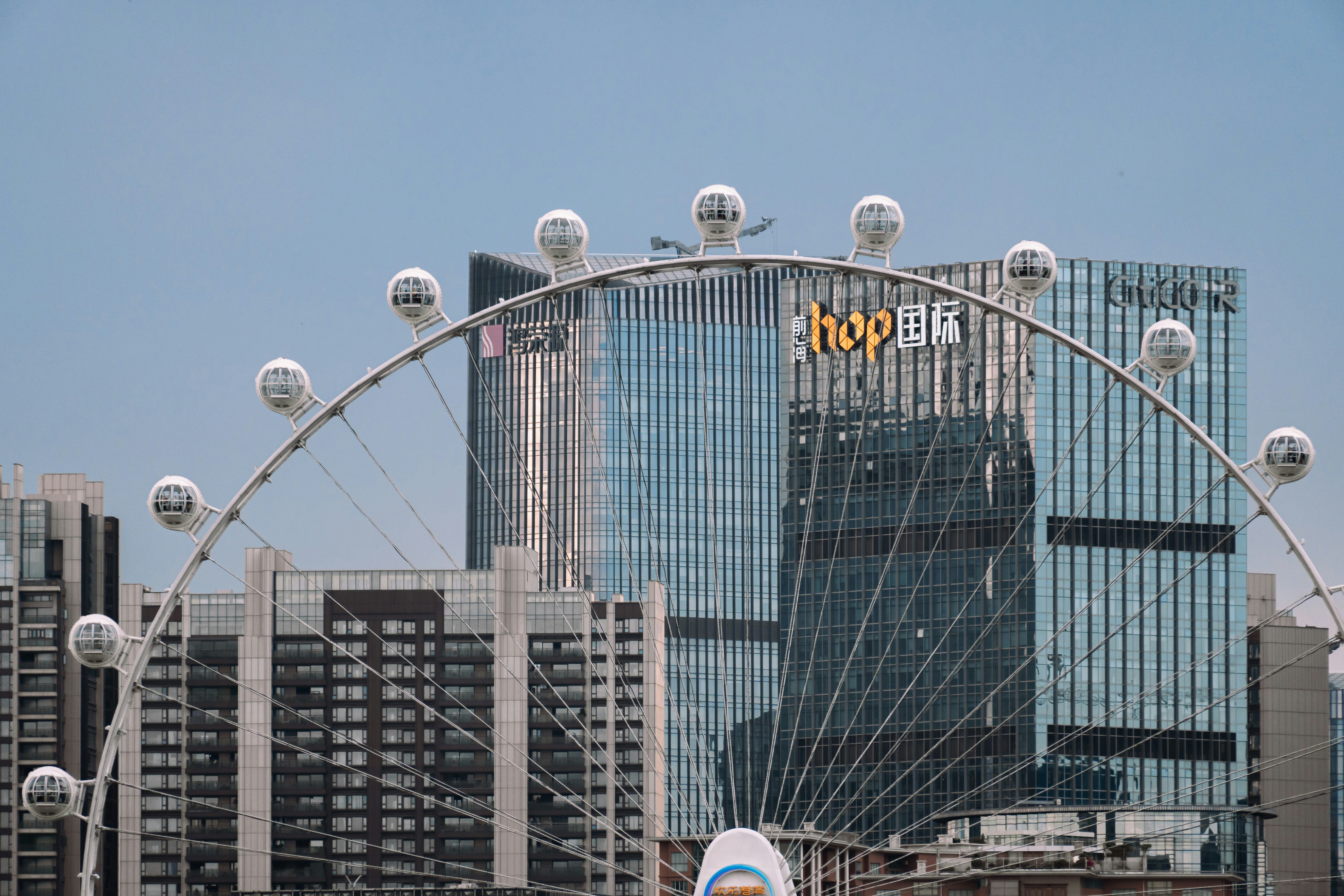 A large building with a ferris wheel in the background photo – Free ...