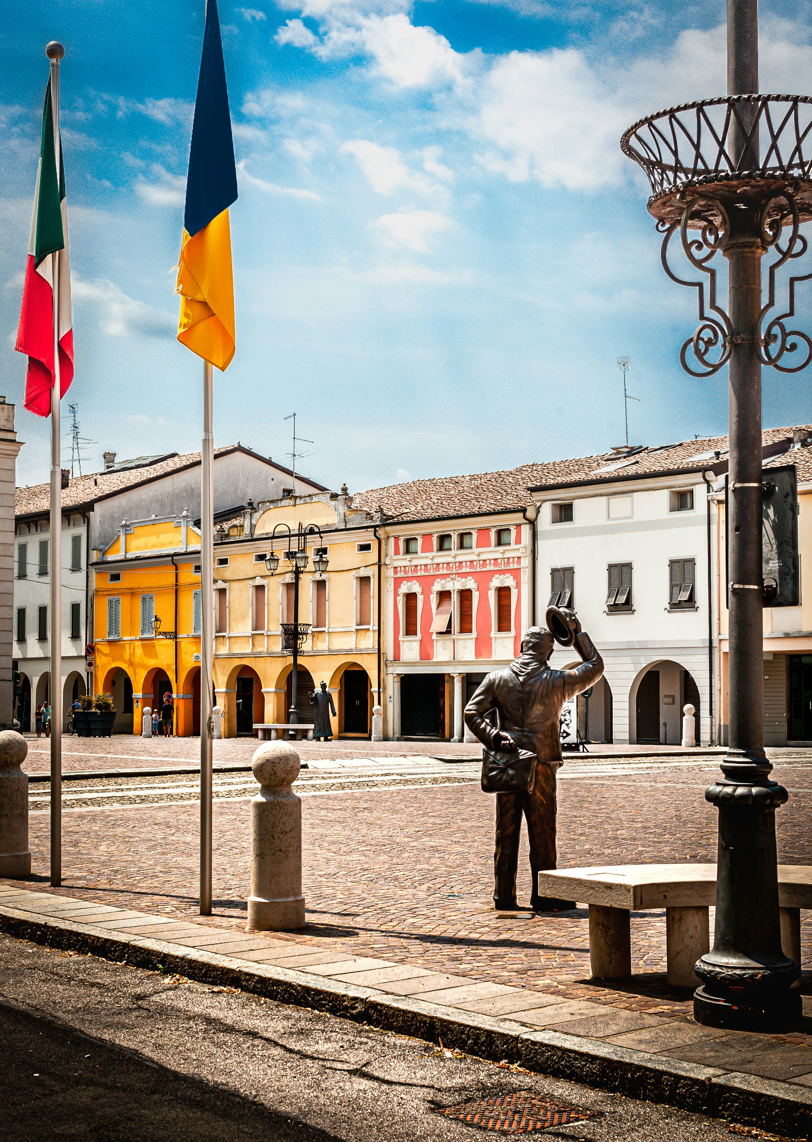 A statue of a person holding a flag in front of a building photo – Free ...