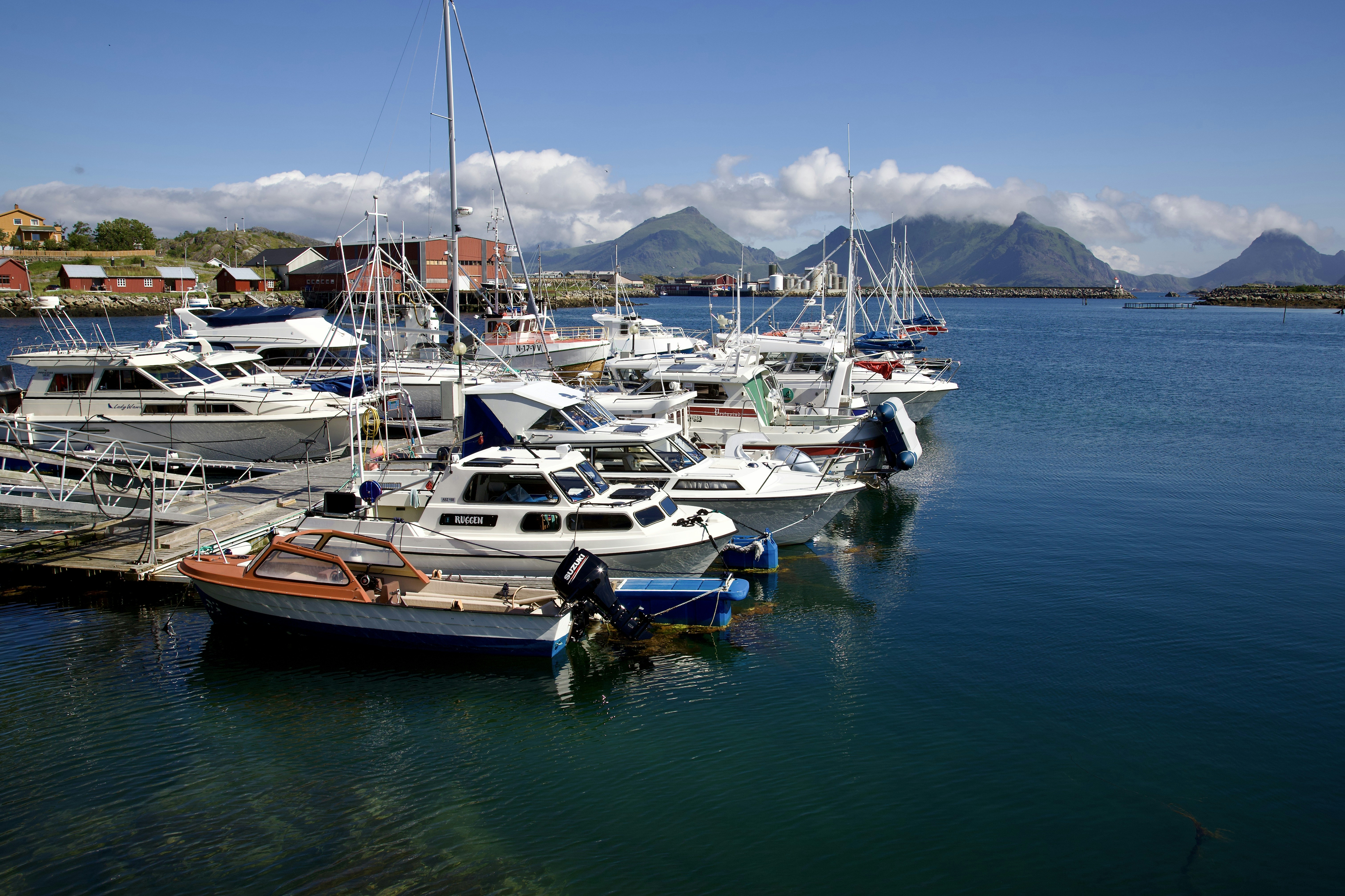 Harbor of Quiet Sails Under Cloud-kissed Peaks