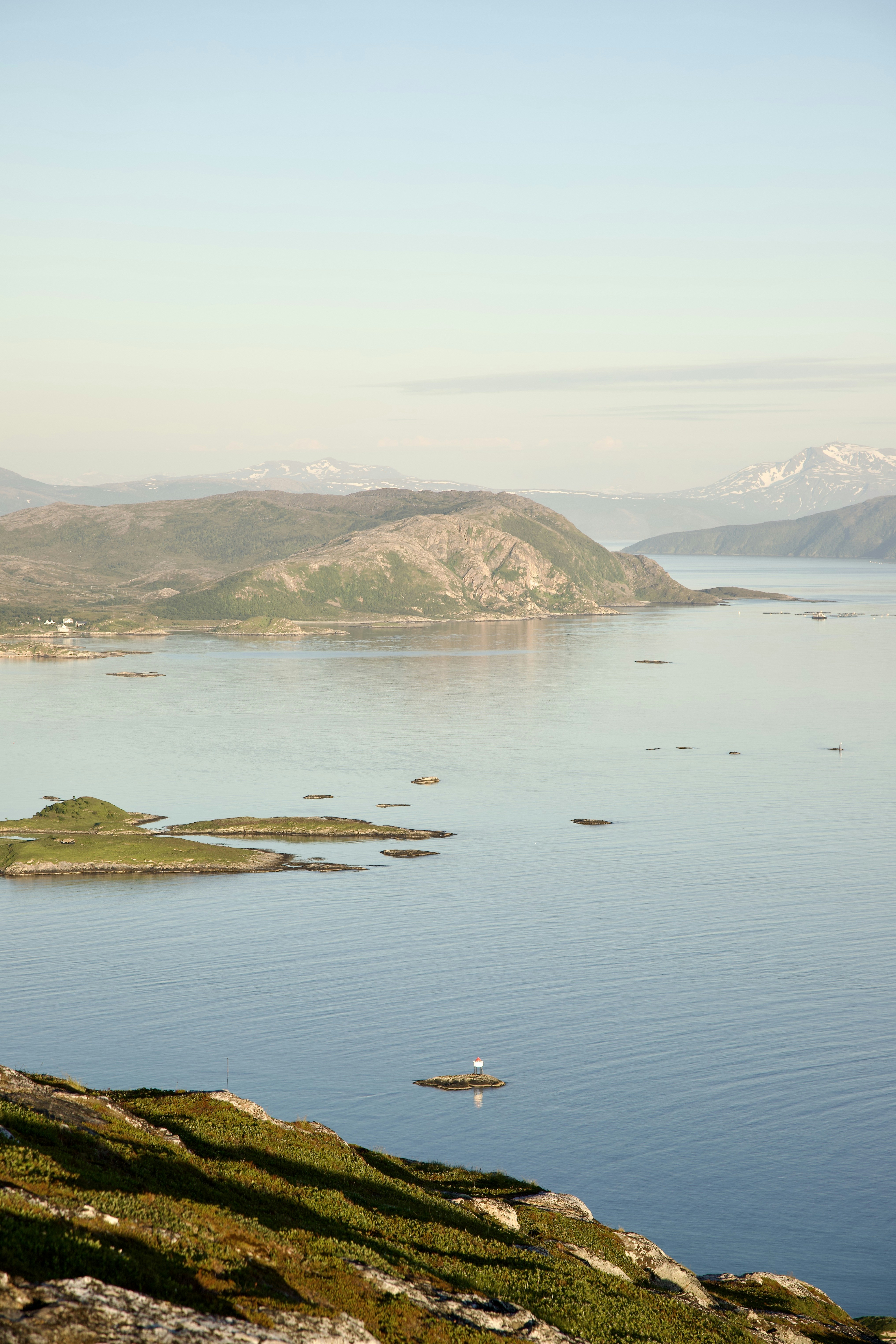 A body of water with land in the back photo – Free Land Image on Unsplash