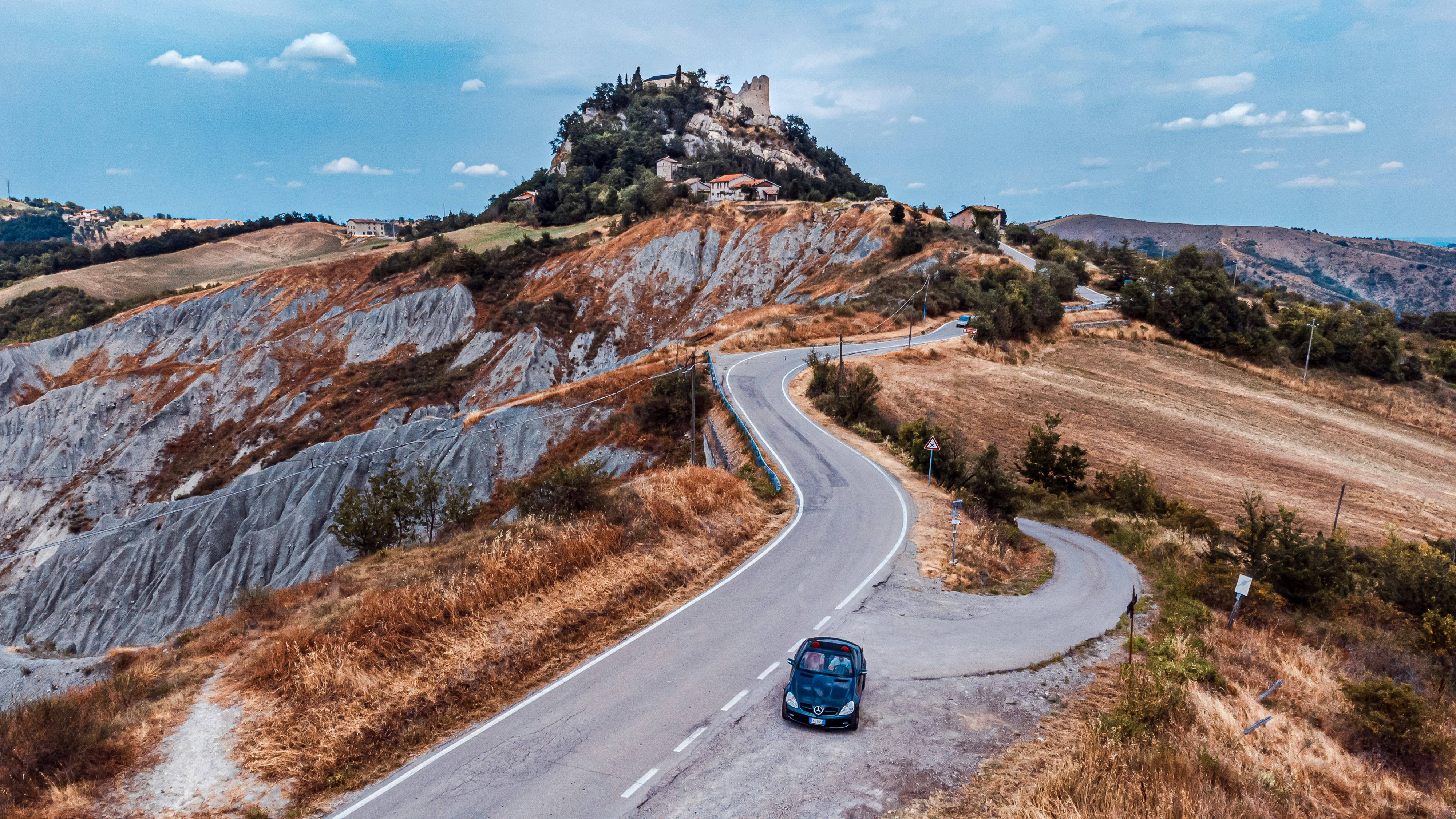 A car driving down a road photo – Free Castello di canossa Image on ...
