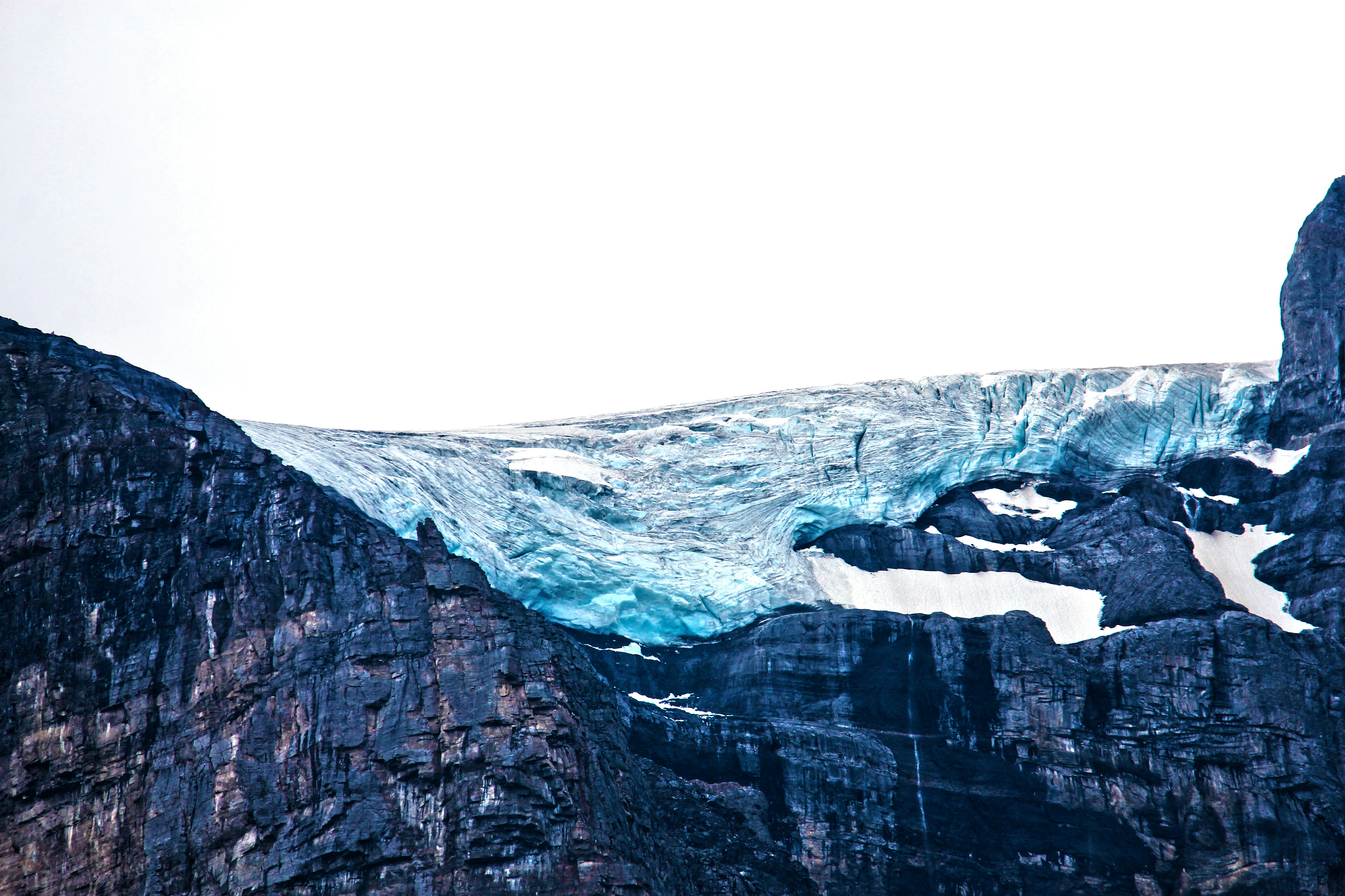 Blue Ice Crown over a Rugged Glacier Cliff