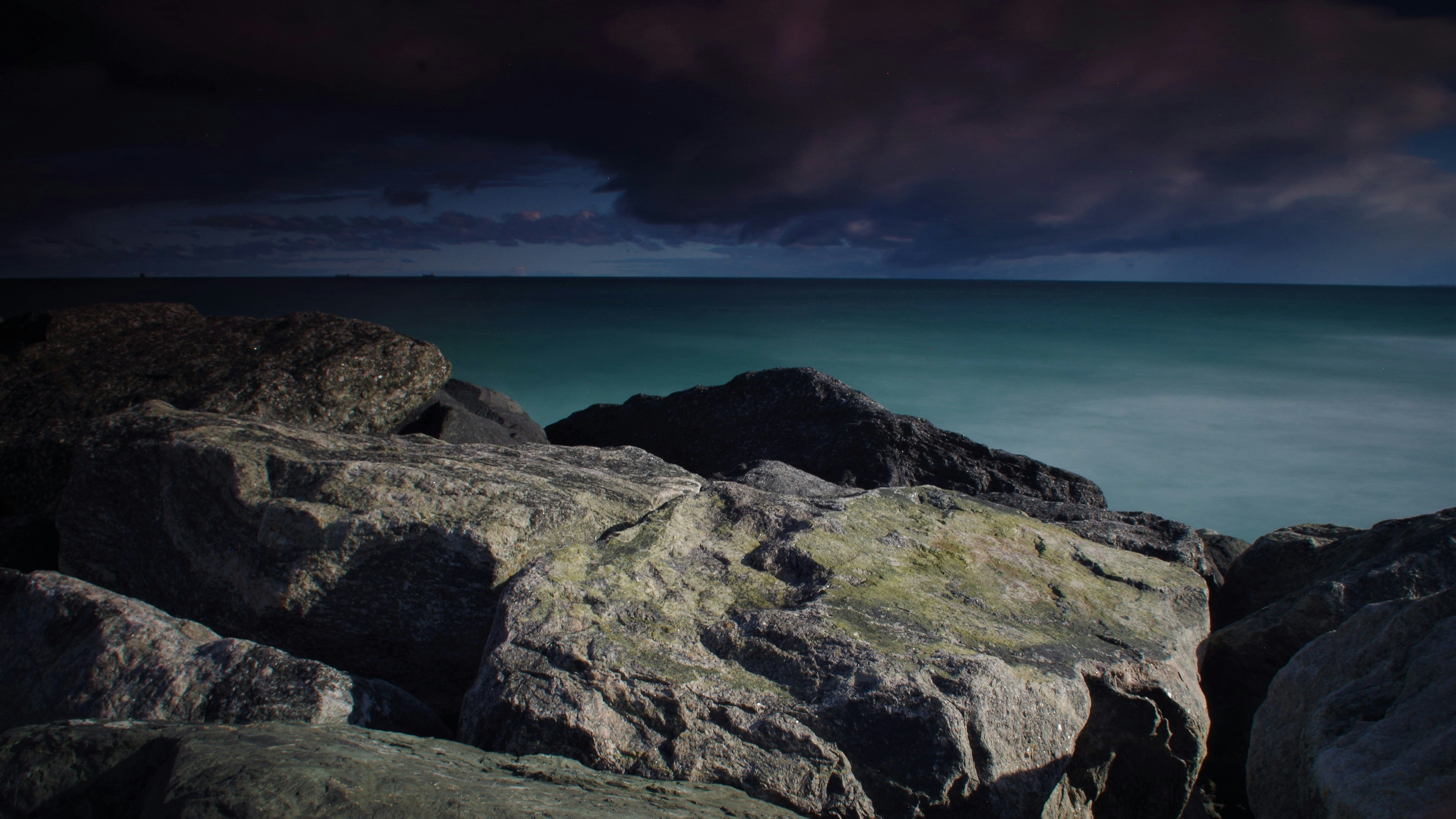 Granite Foreground at Dusk: Quiet Divide Between Sea and Sky