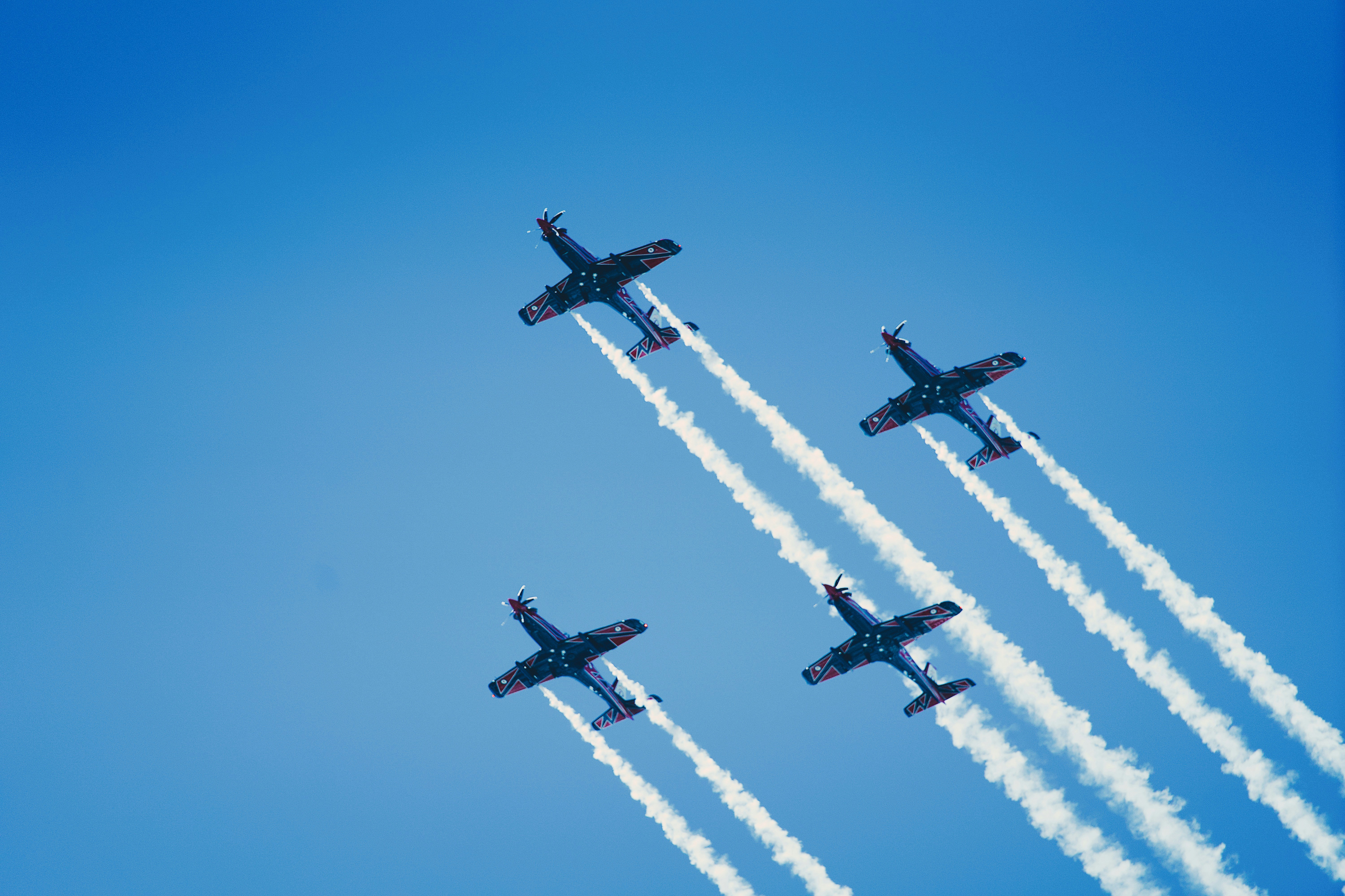 A group of airplanes fly through the air photo – Free Blue Image on ...