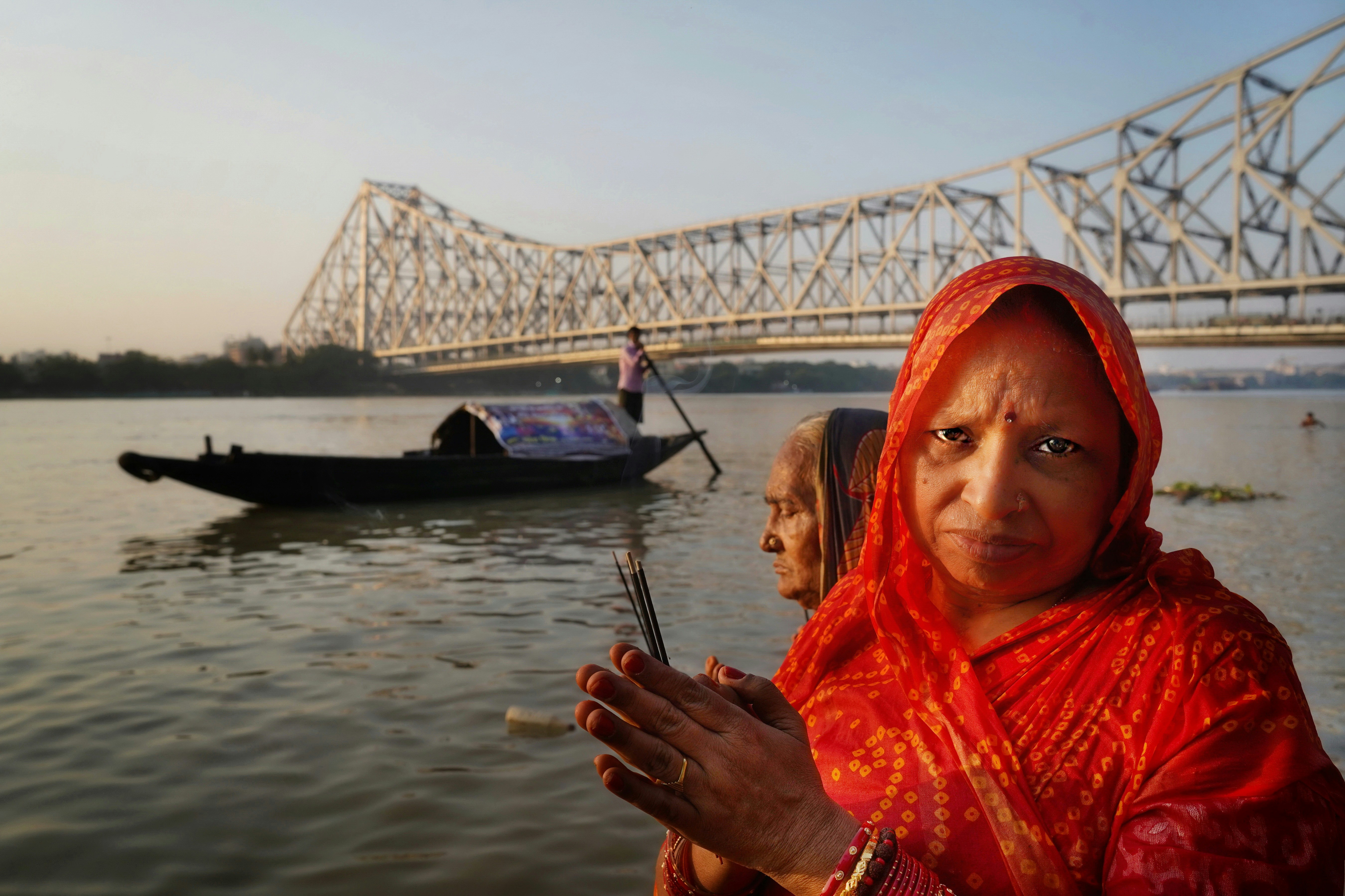 Red-veil Candor by the Hooghly: A River Scene with Looming Bridge