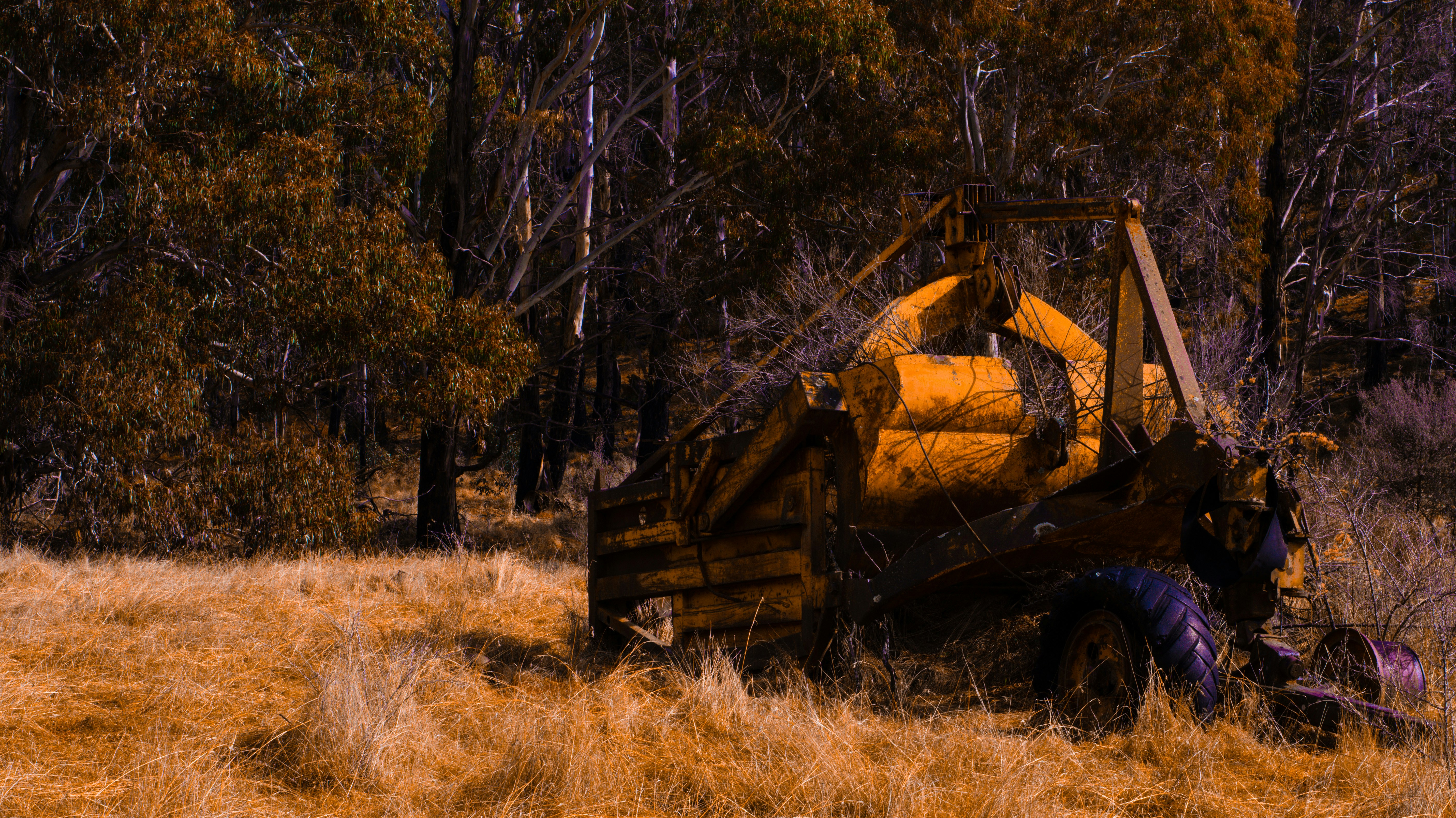 Harvest of Rust: An Old Tractor Resting in a Golden Field