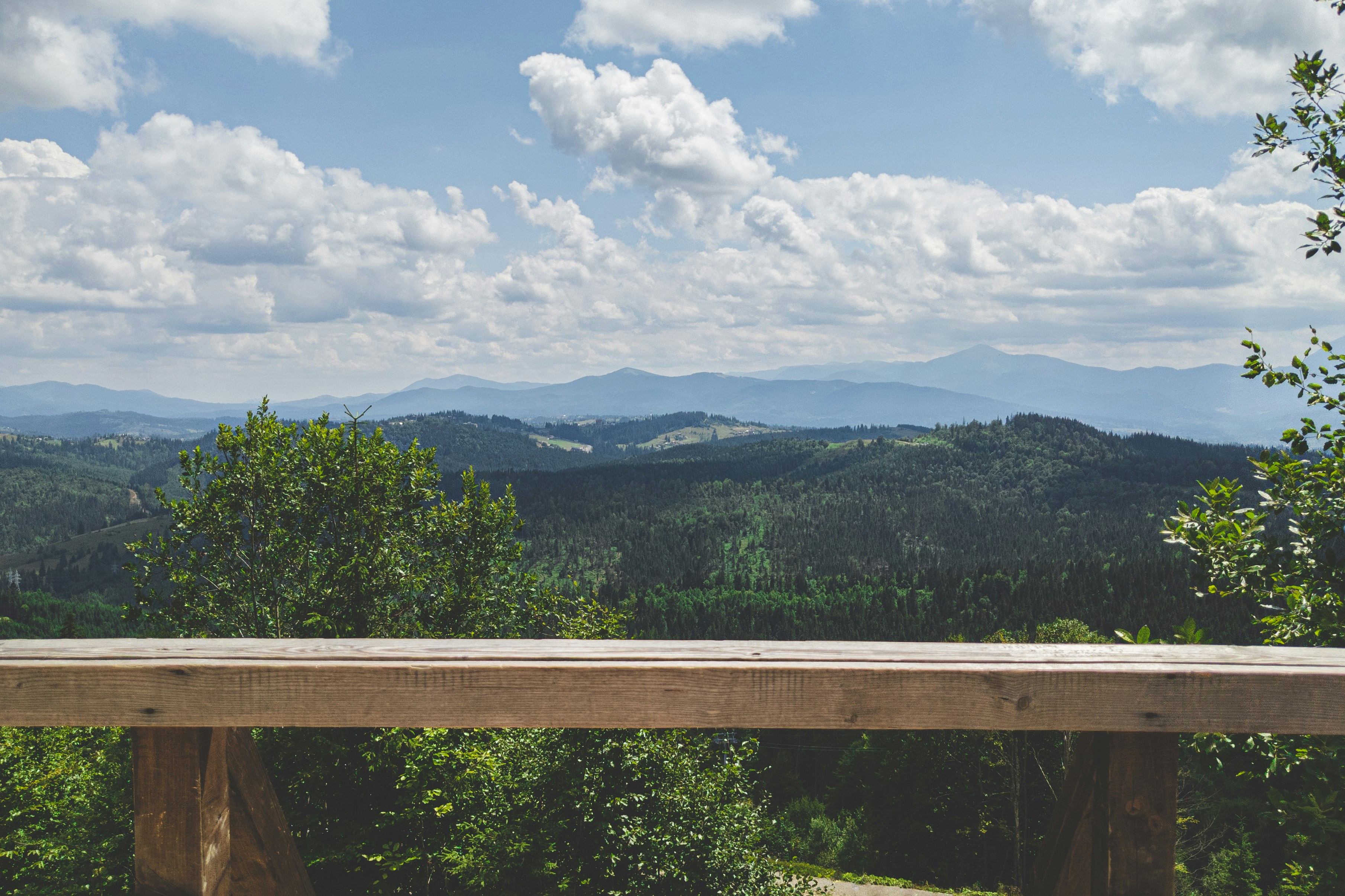 Ridgeview Overlook: Rolling Hills Fade into a Cloud-Threaded Horizon