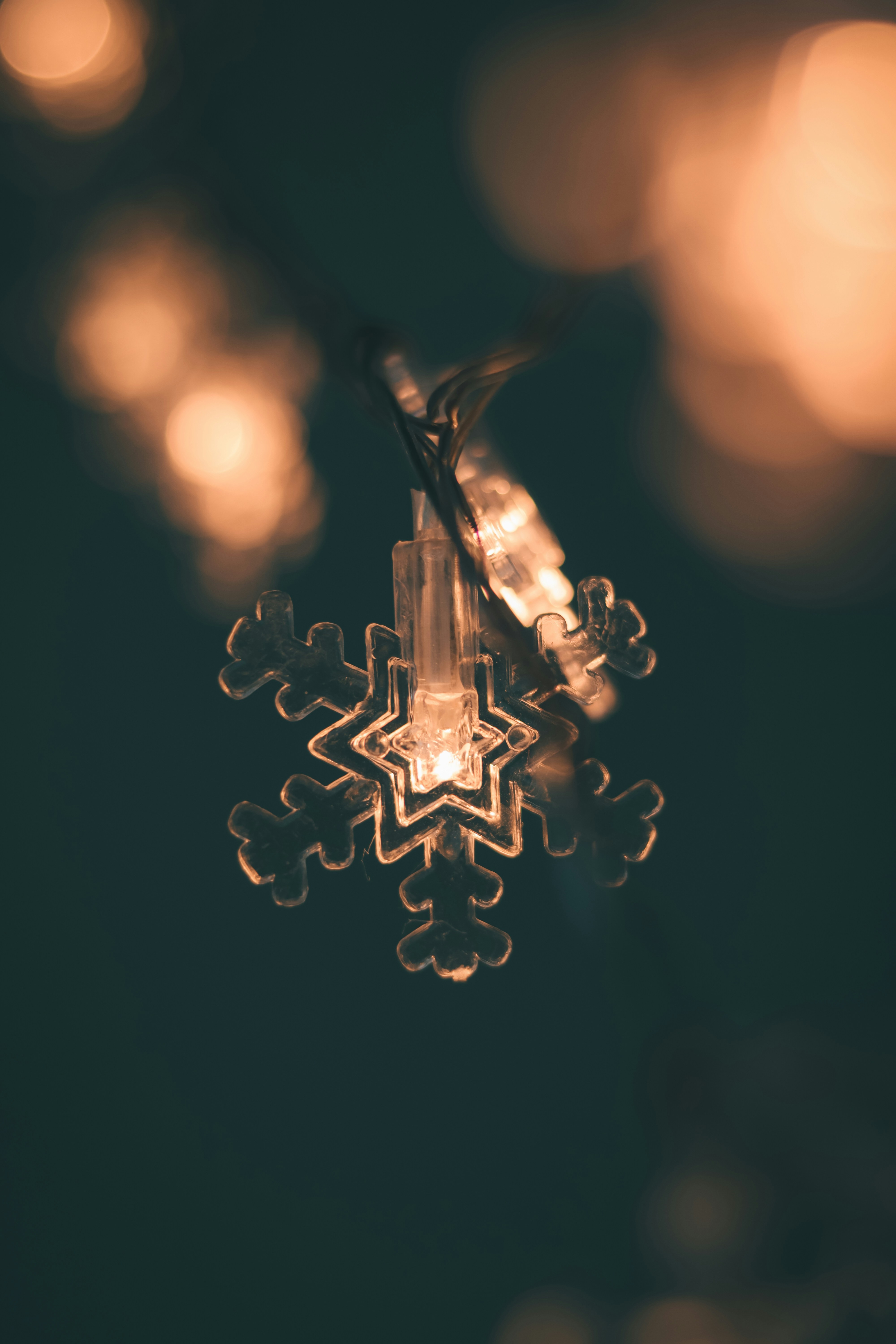 Amber Snowflake Pendant in a Sea of Golden Bokeh
