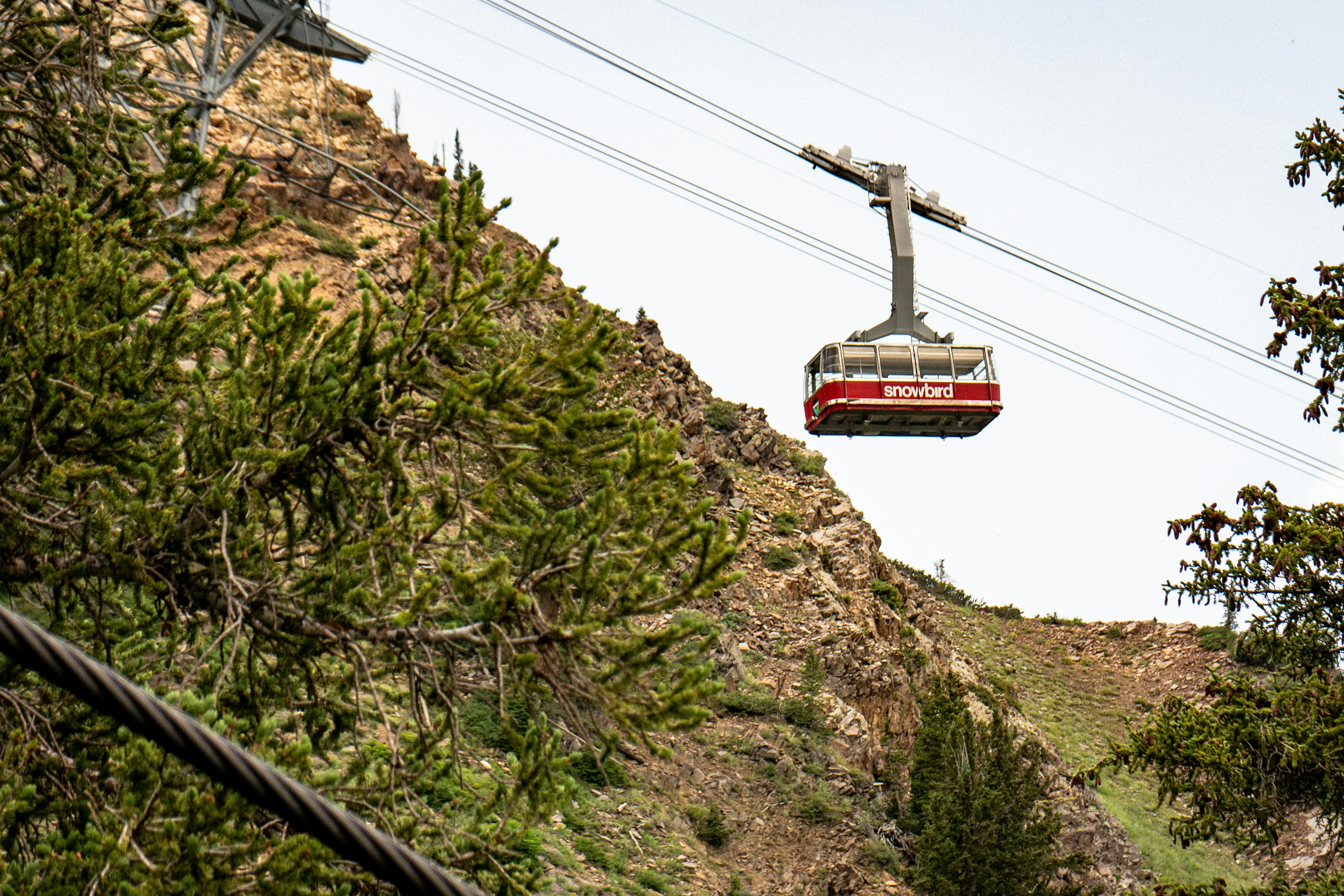 A cable car going over a hill photo – Free Tram Image on Unsplash